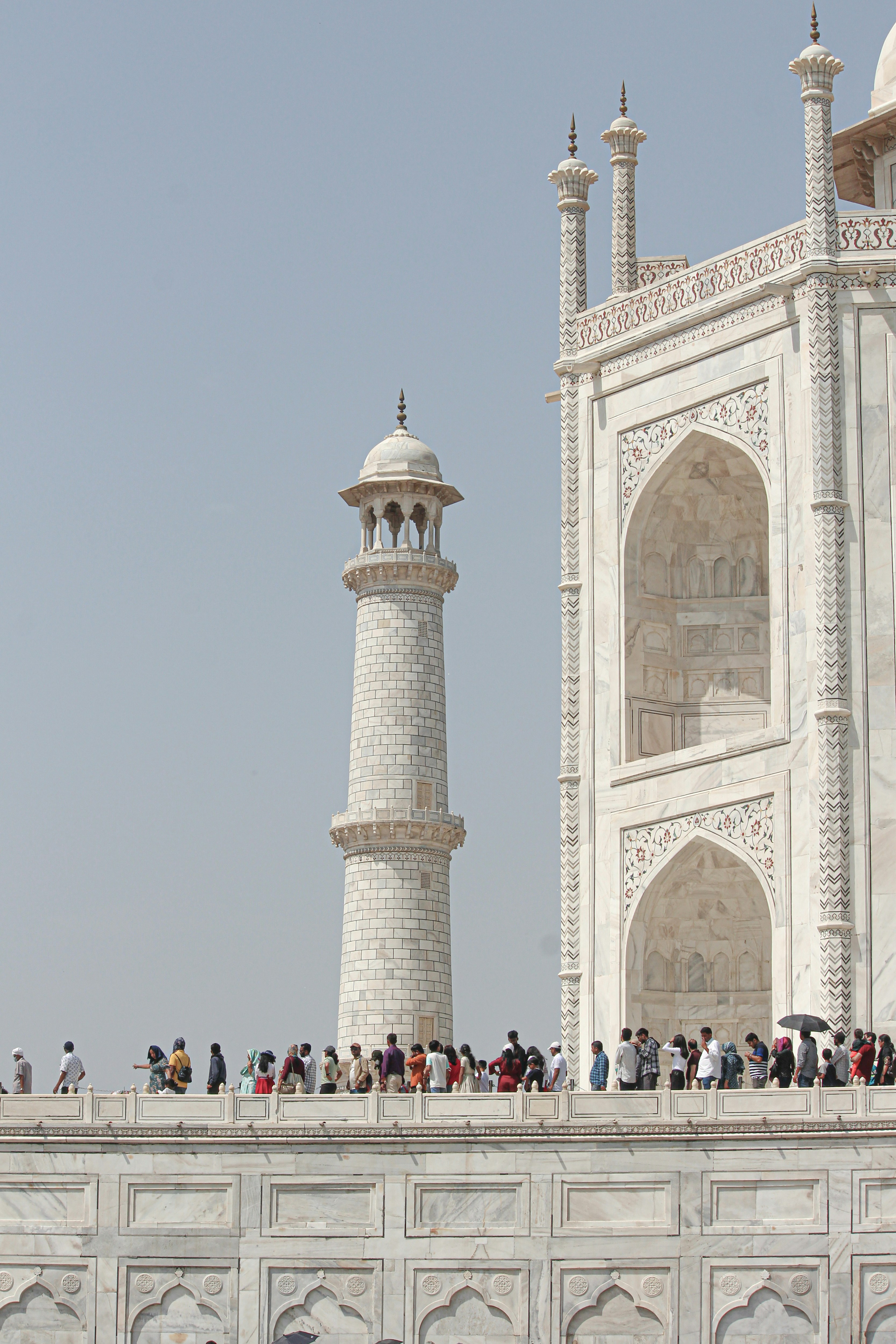 Ivory Minaret and Marble Facade Framed by a Crowd on the Terrace