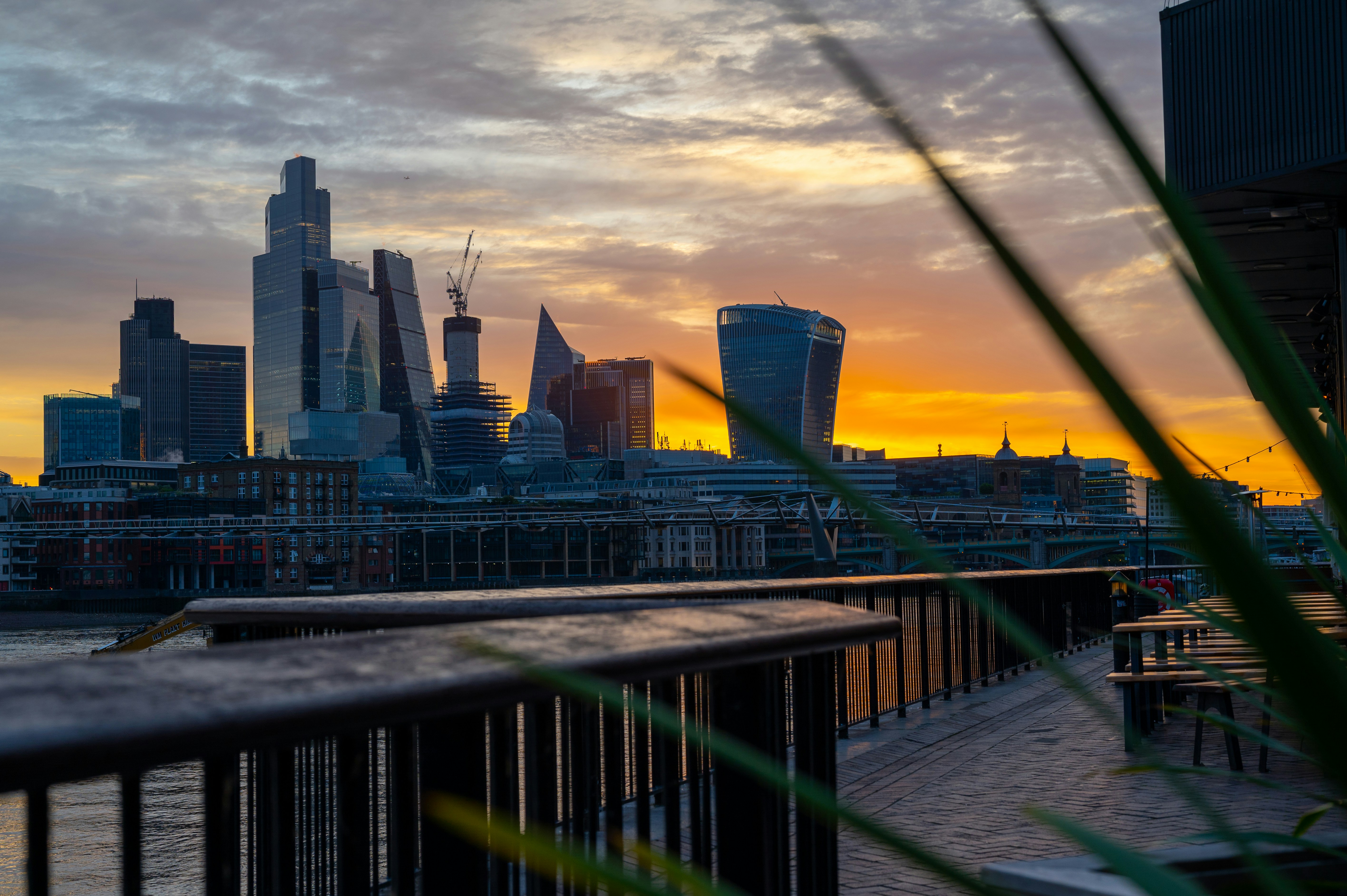 Sunset Skyline Over a Quiet Riverside Boardwalk