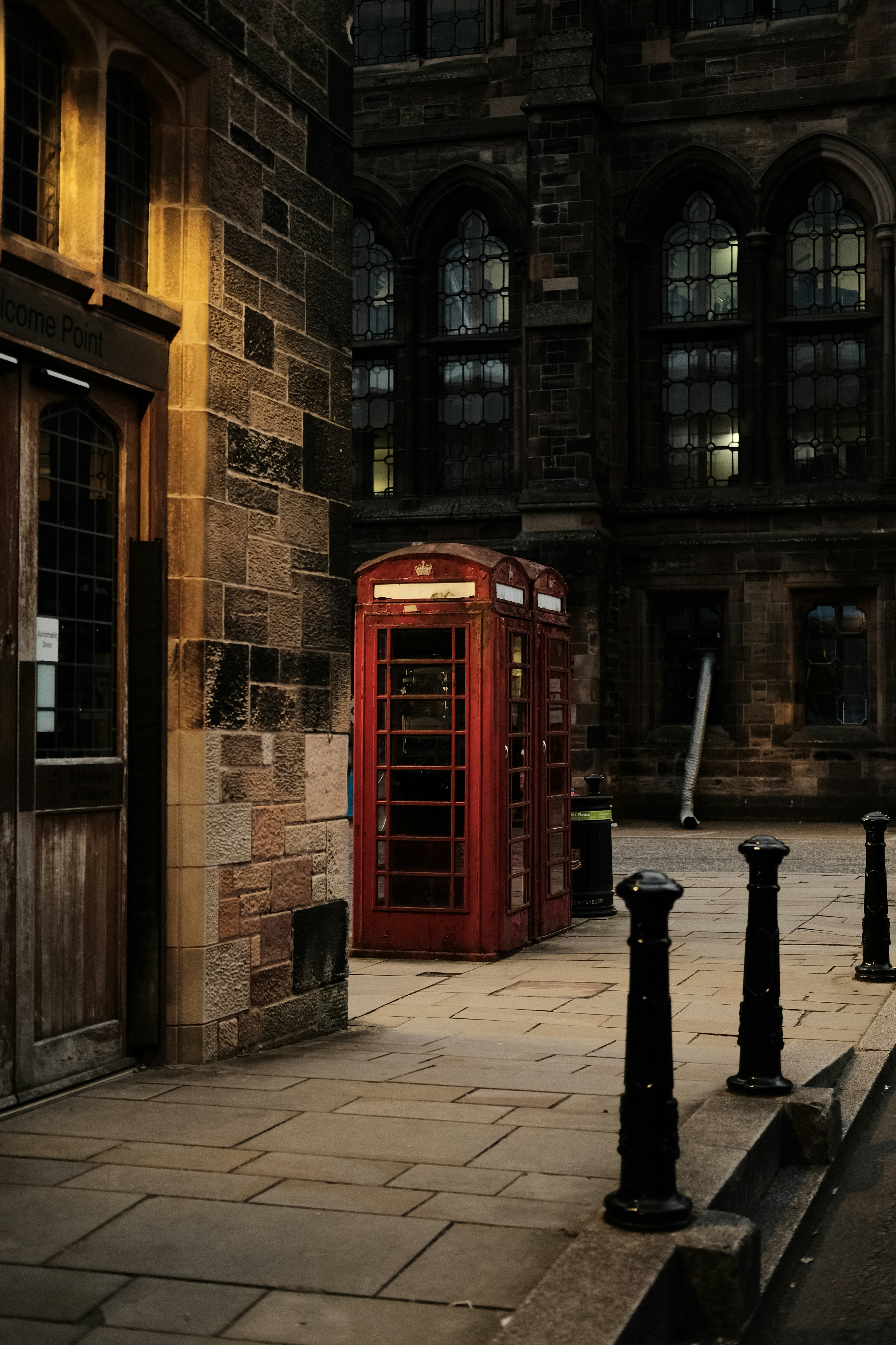 Red Phone Booth at Dusk: A Gothic Street's Quiet Sentinel