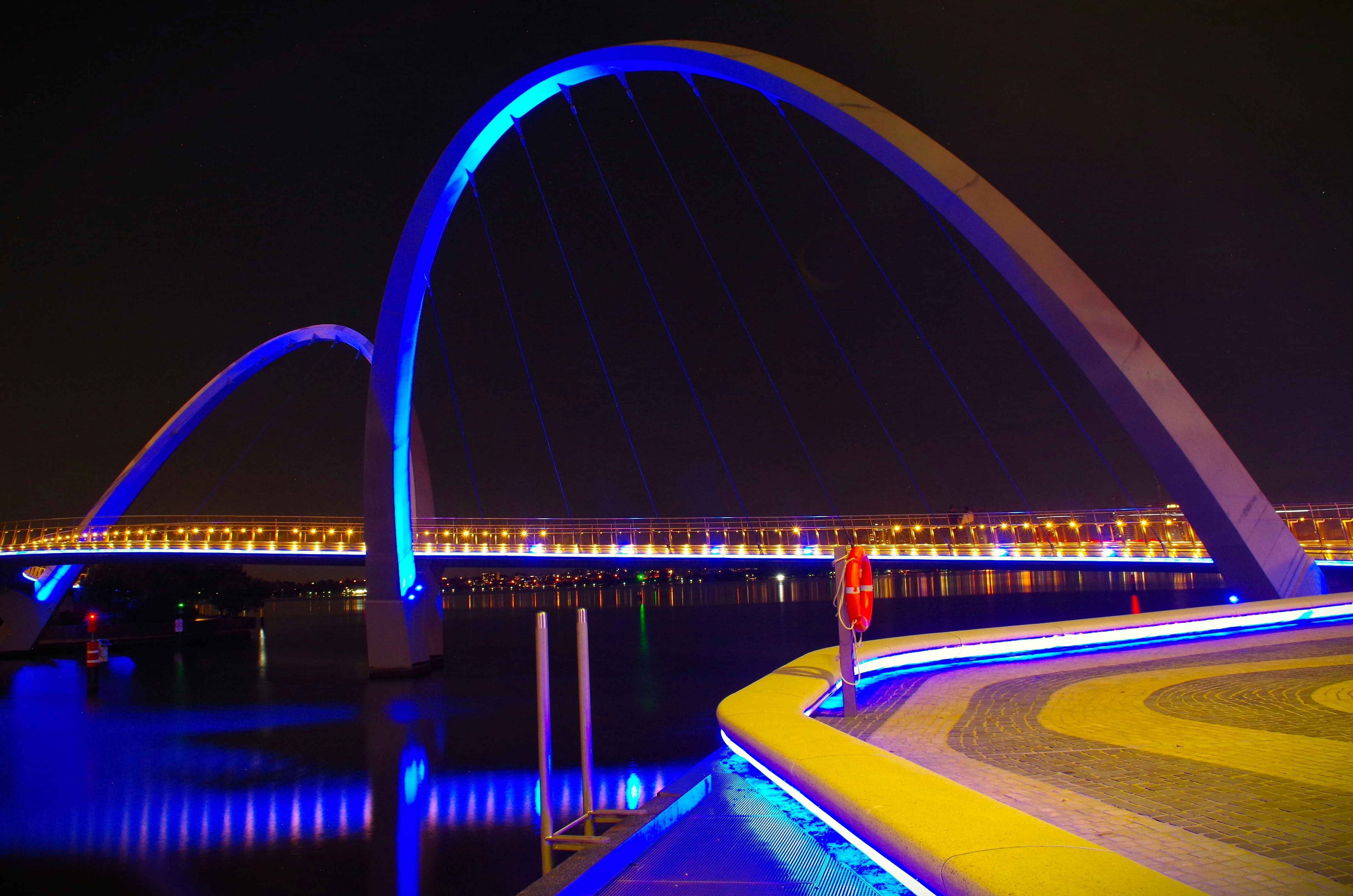 A bridge that is lit up with blue lights photo – Free Perth western ...