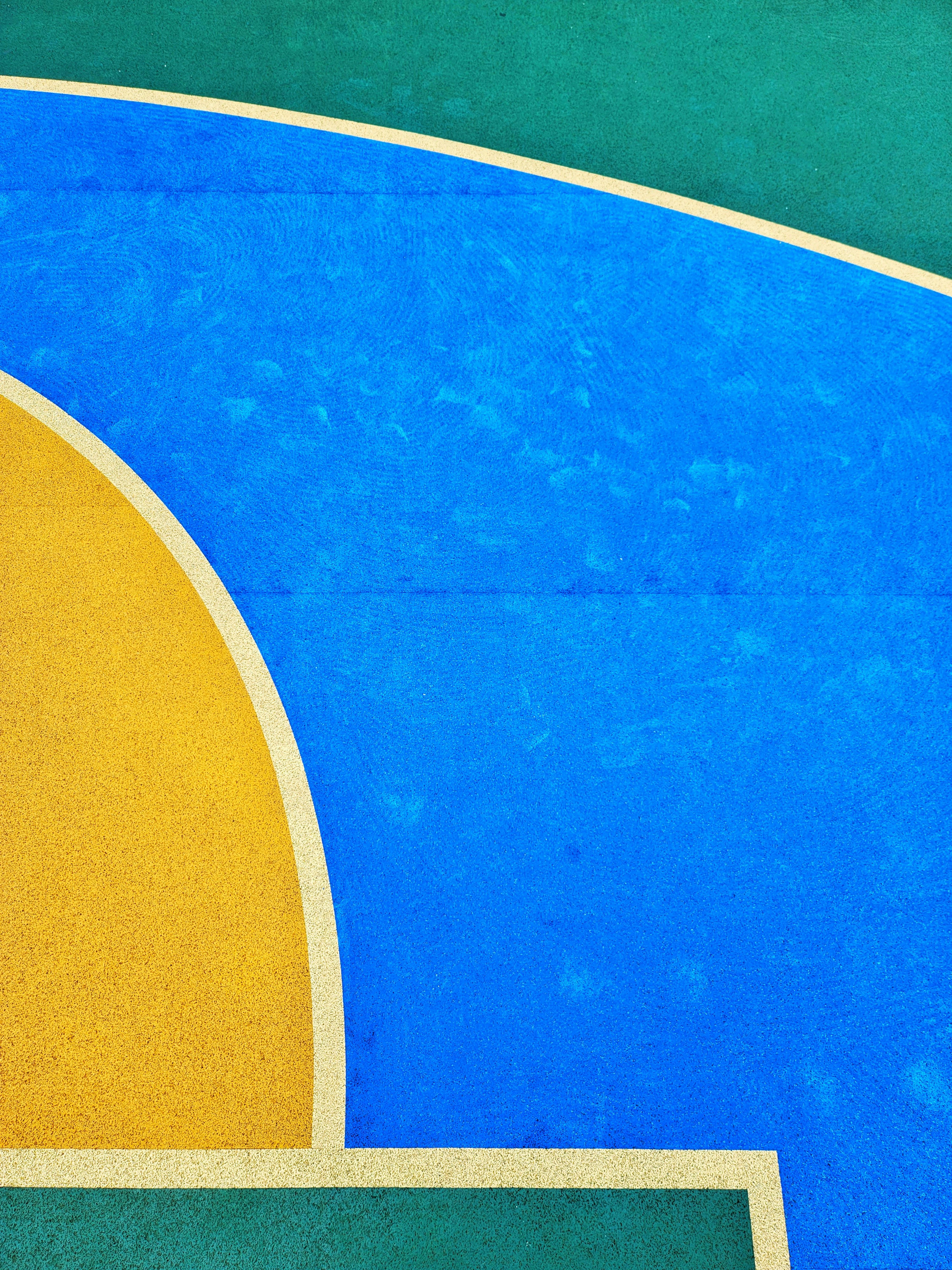 Vibrant abstract design with bold blue, yellow, and green sections divided by white lines.