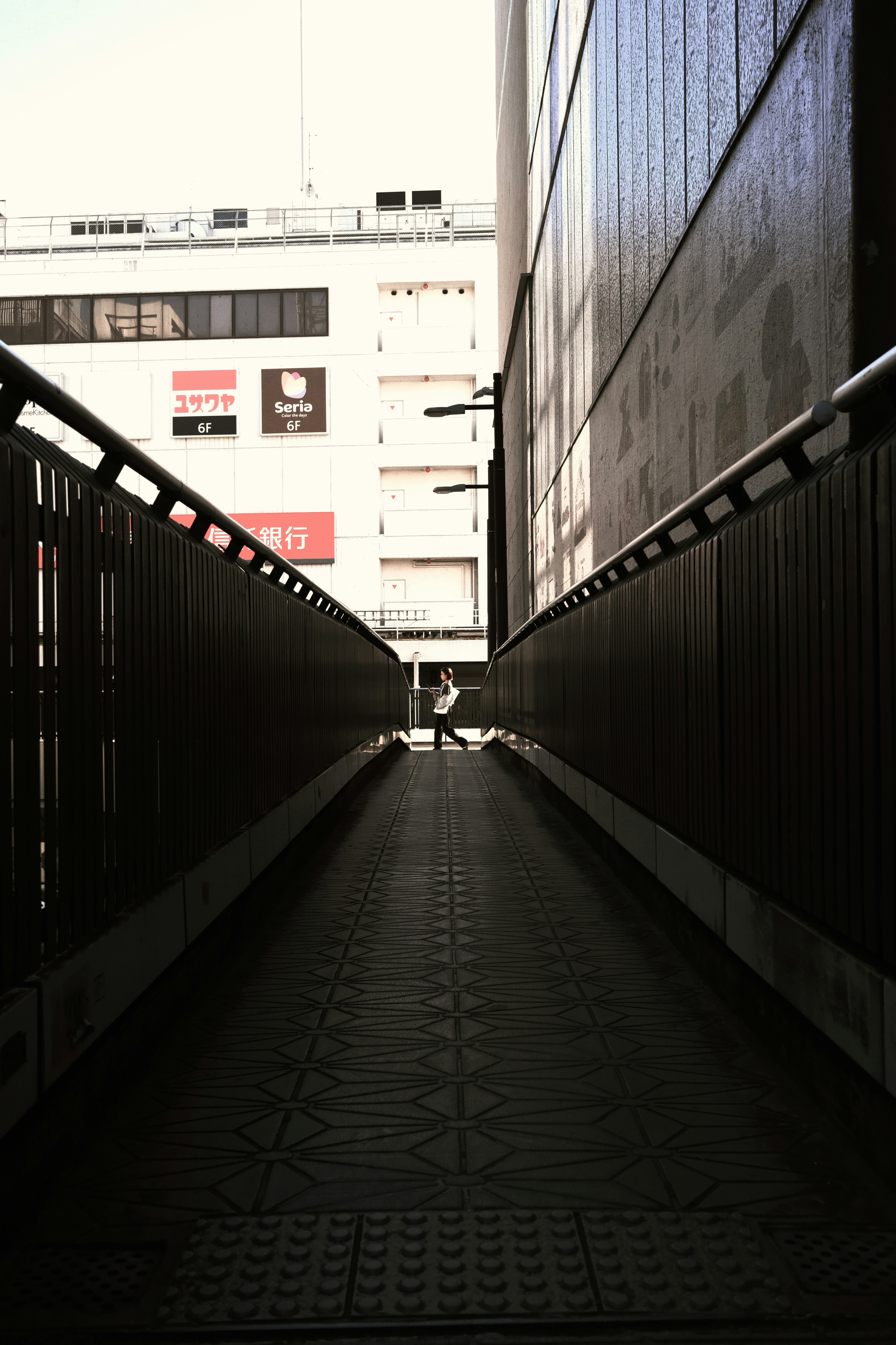 A walkway between two buildings in a city photo – Free Building Image ...