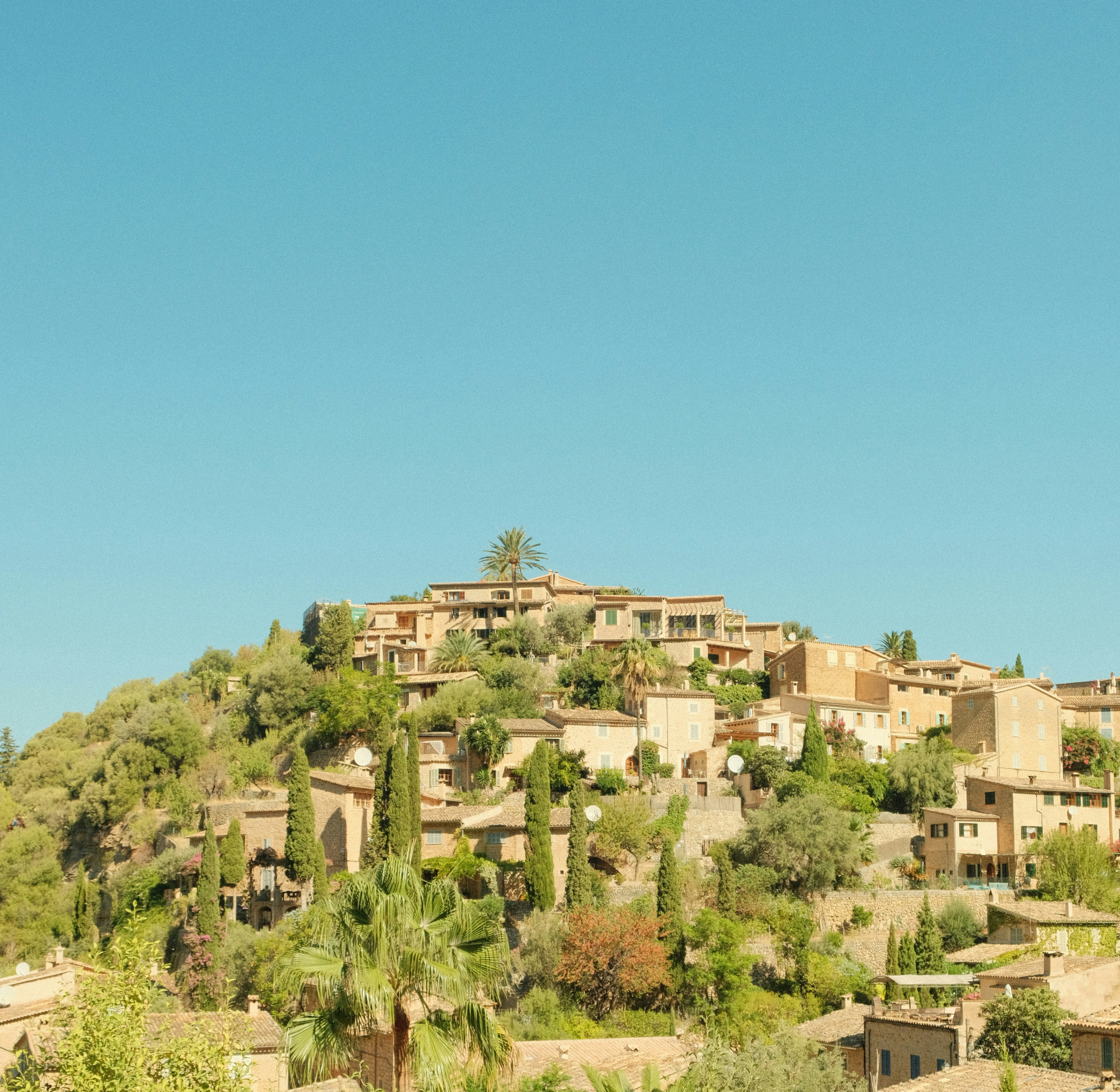 Terraced Crest: A hillside hamlet bathed in sun and blue sky