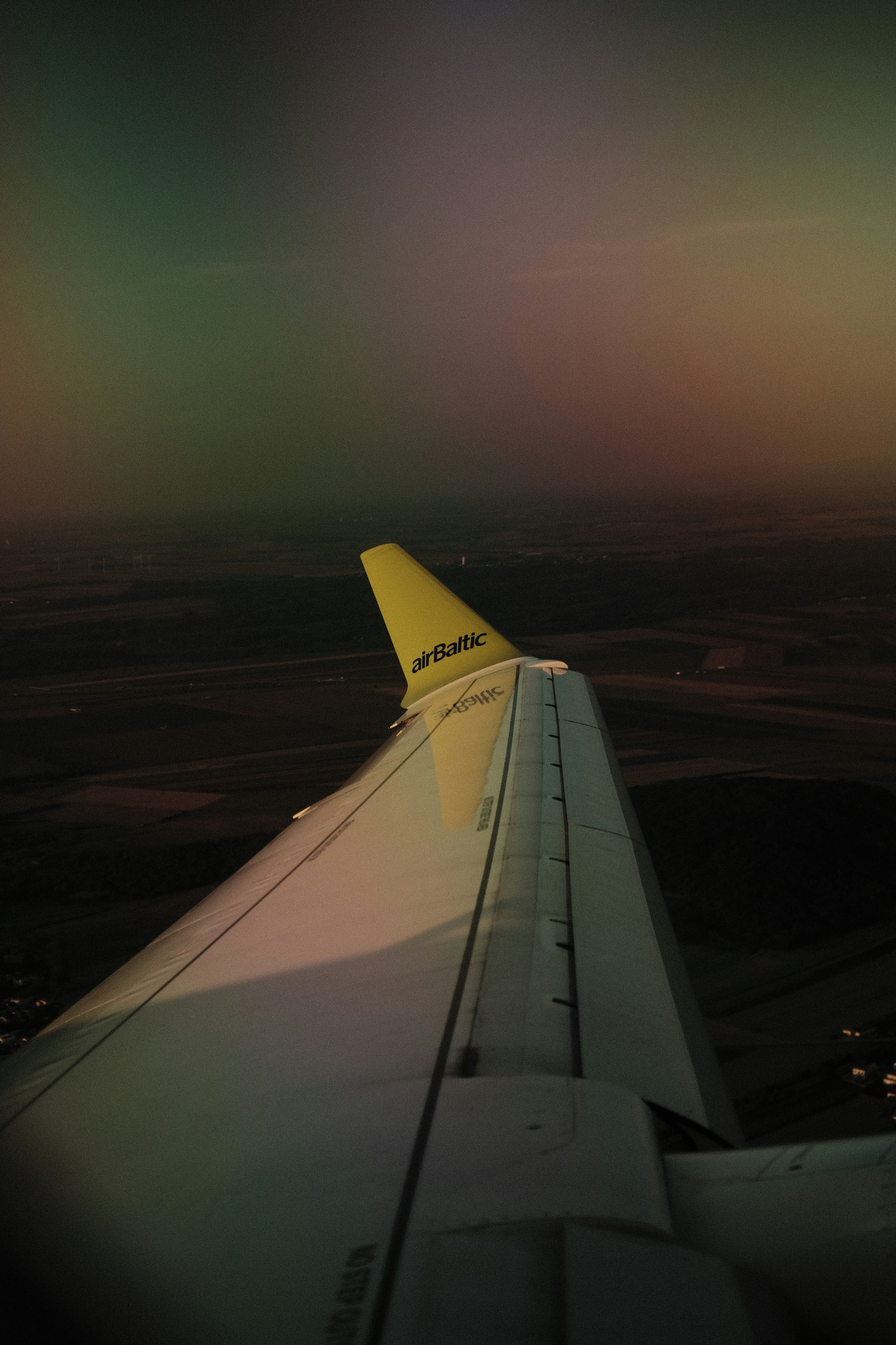 View on the airplane wing with a rainbow