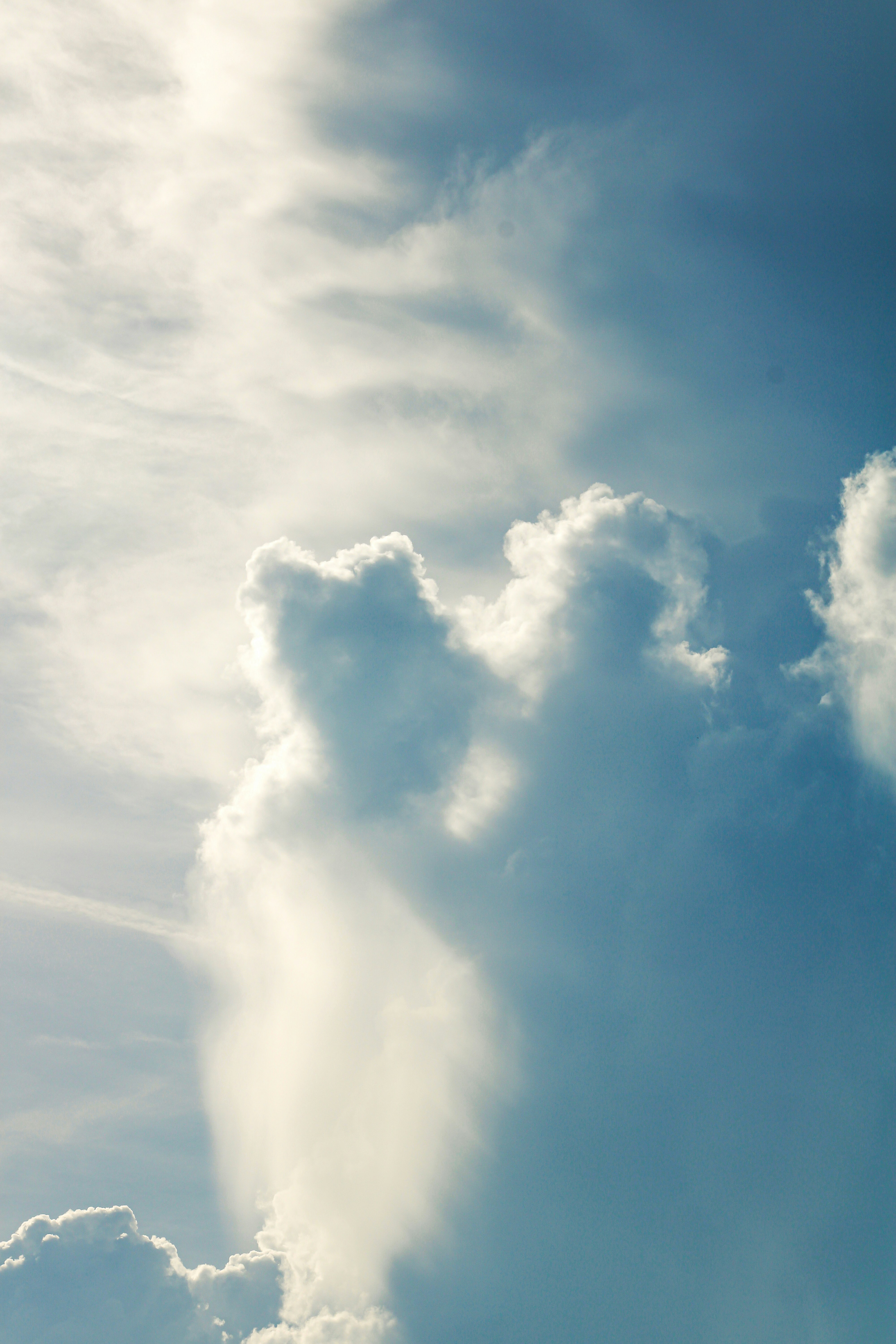 Sunlit Cloud Column Rising Over a Cerulean Sky