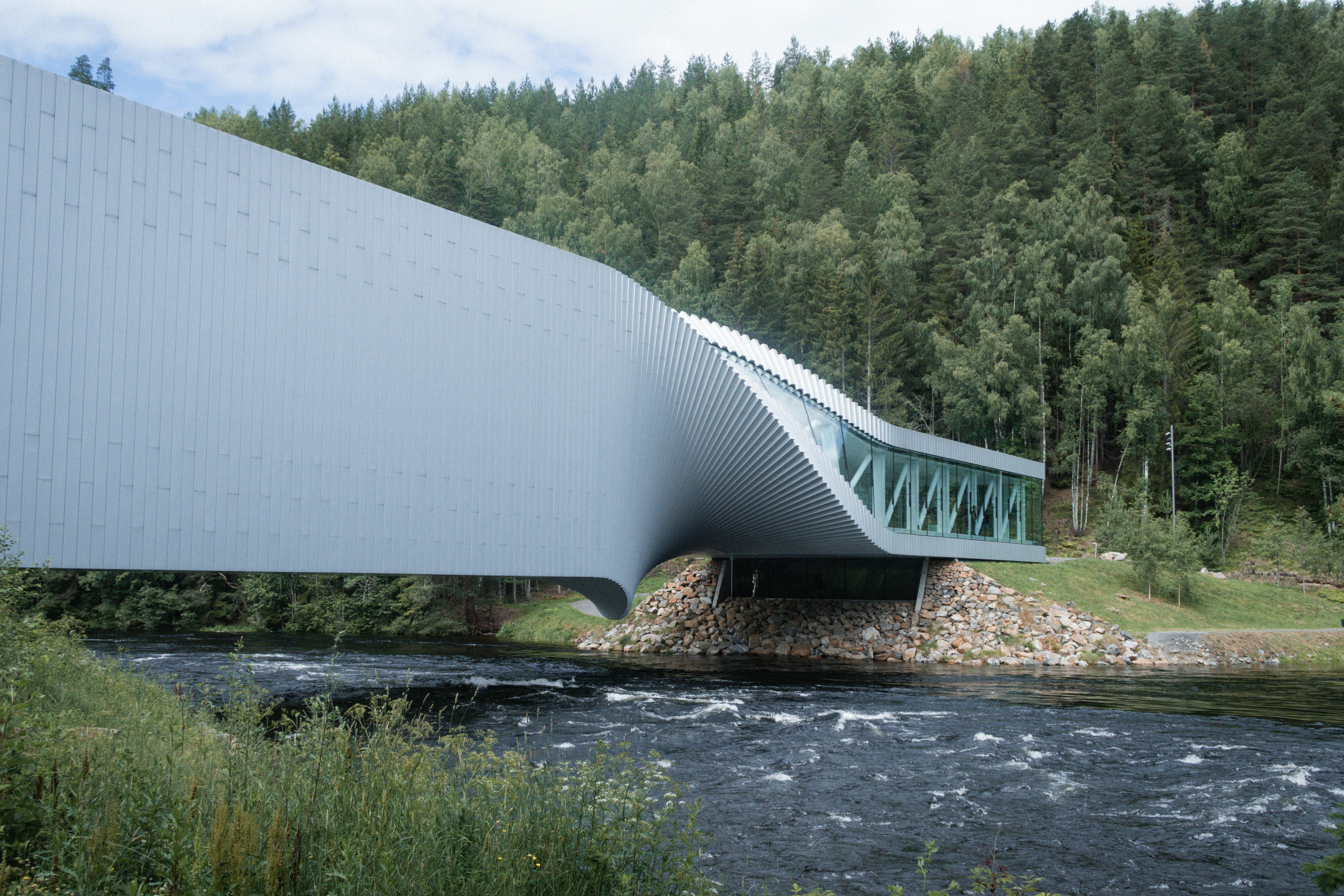 A large bridge over a river next to a forest photo – Free Norway Image ...