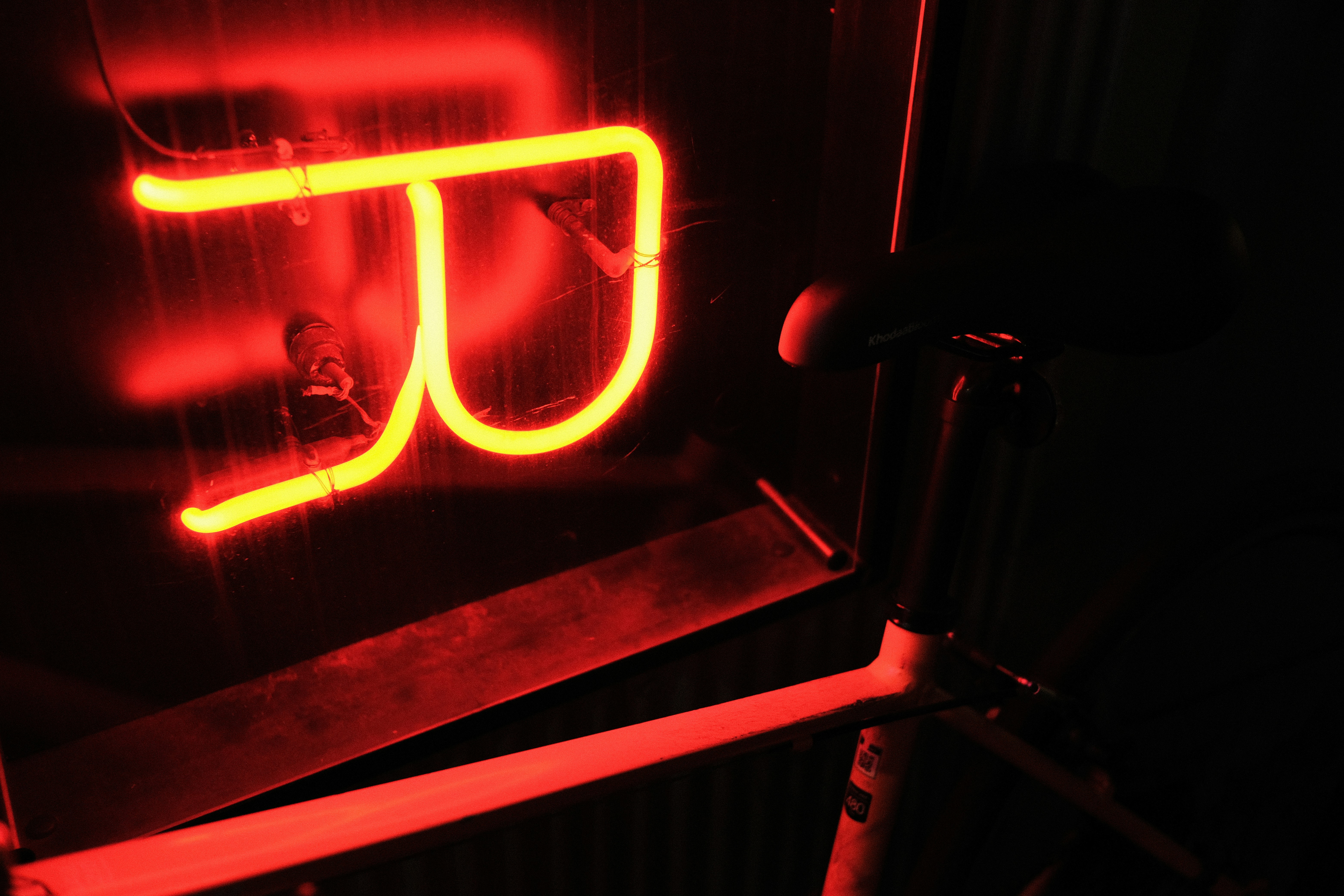 A neon pi sign on the side of a building photo – Free Dōtonbori Image ...