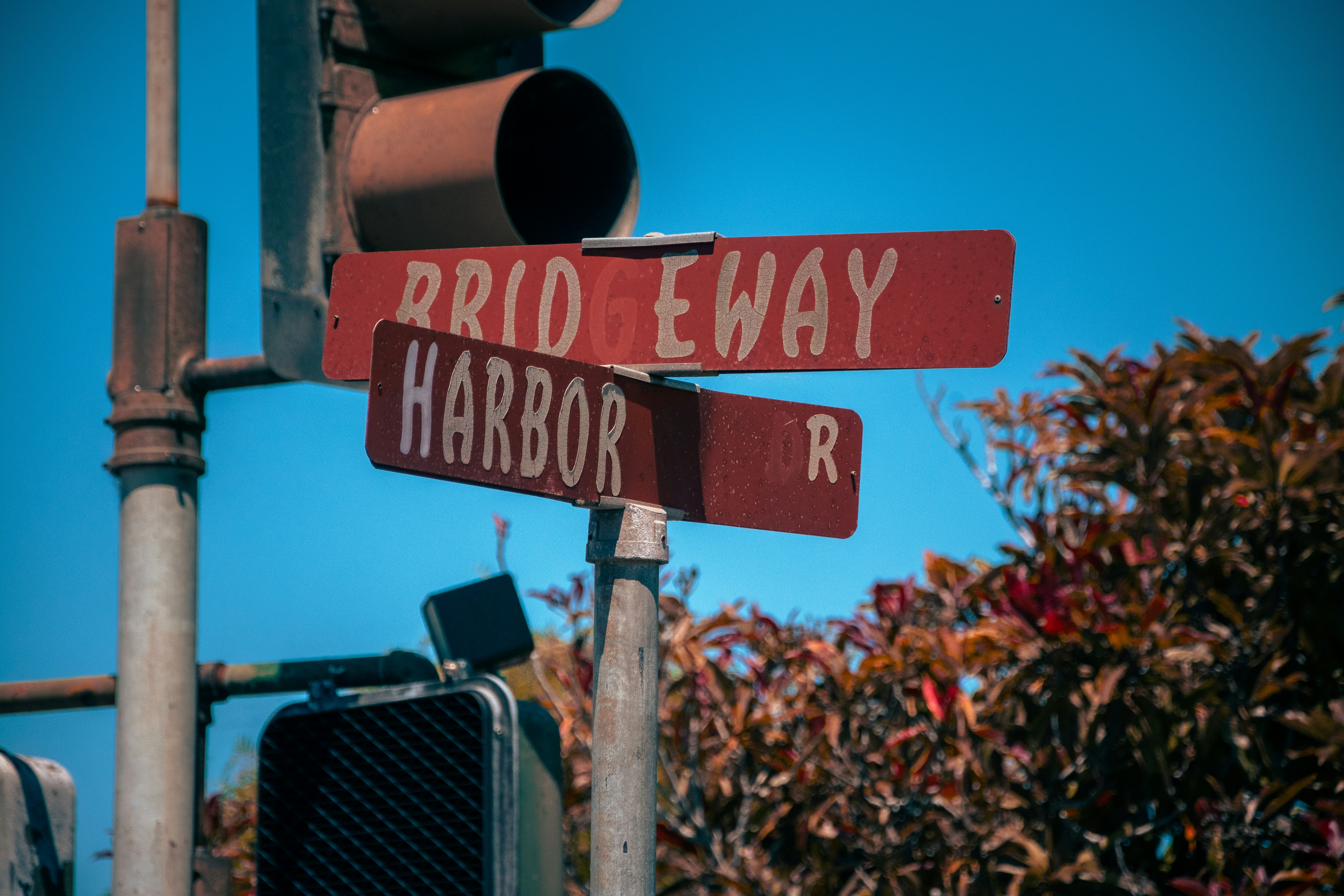 A close up of a street sign with a traffic light in the background ...