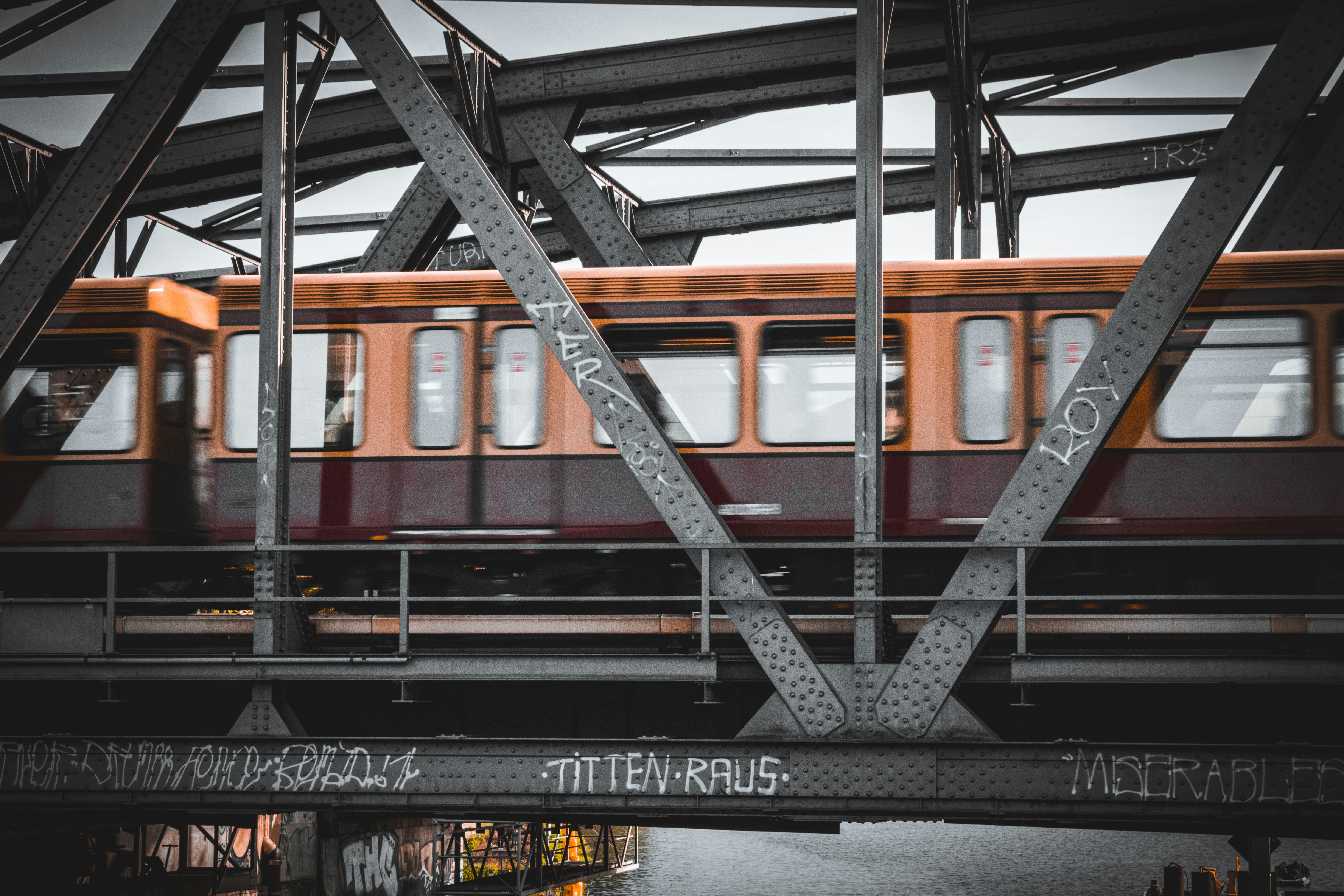 Orange Commuter in a Web of Steel: Crossing the Graffitied Bridge