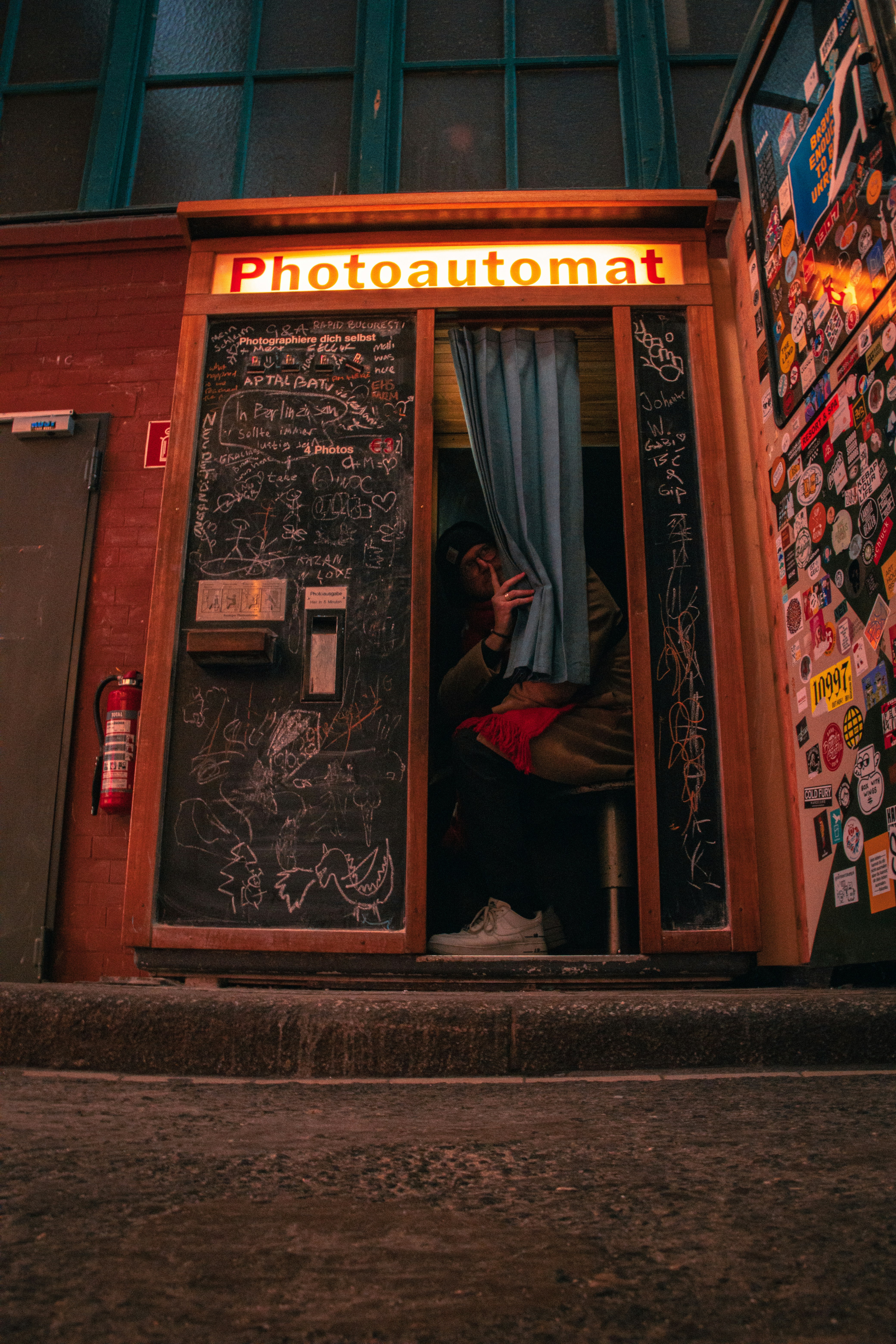 Shadowed Glance Through the Photoautomat Curtain