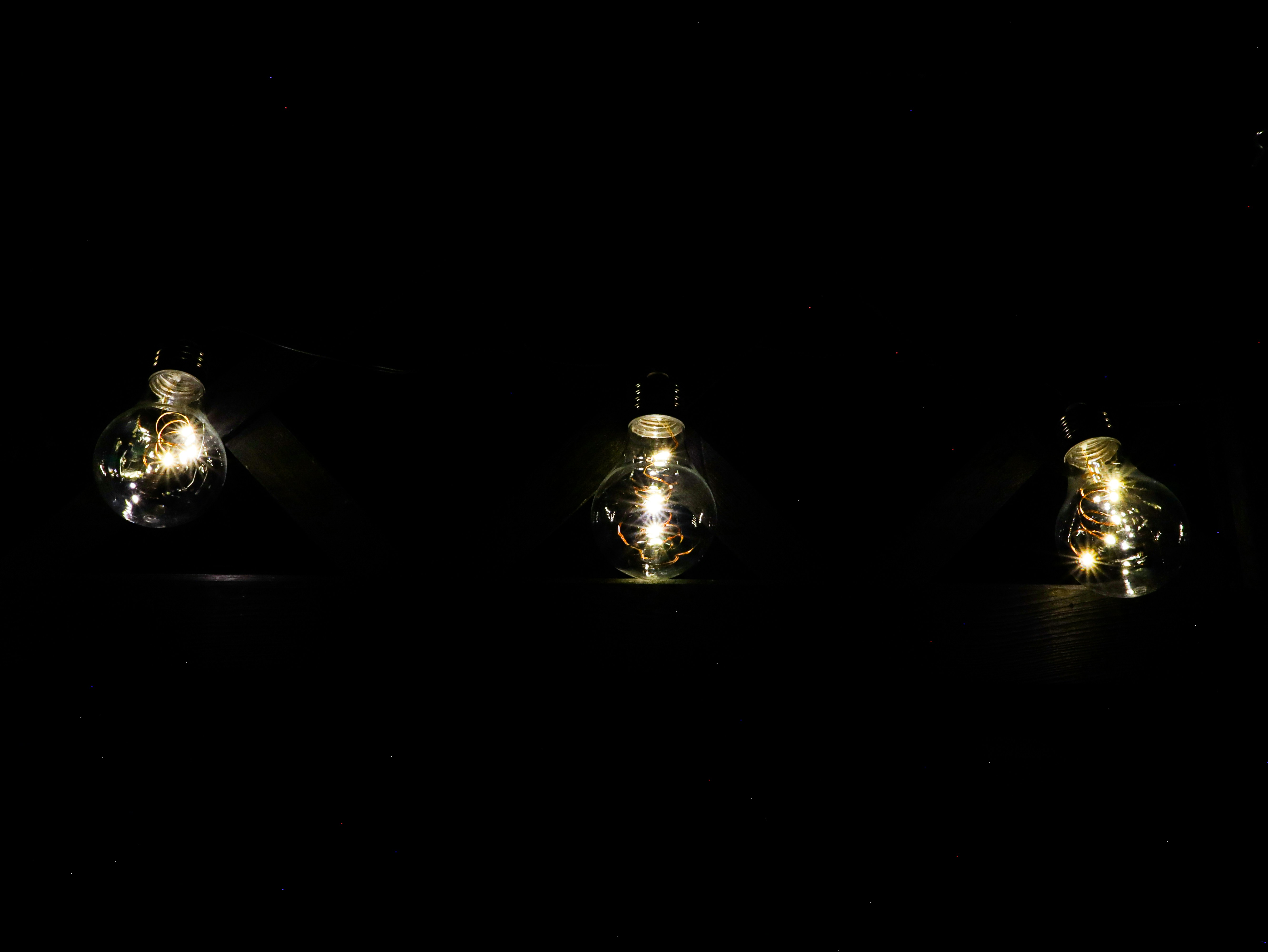Three Halos: A Quiet Trio of Glowing Orbs in the Dark