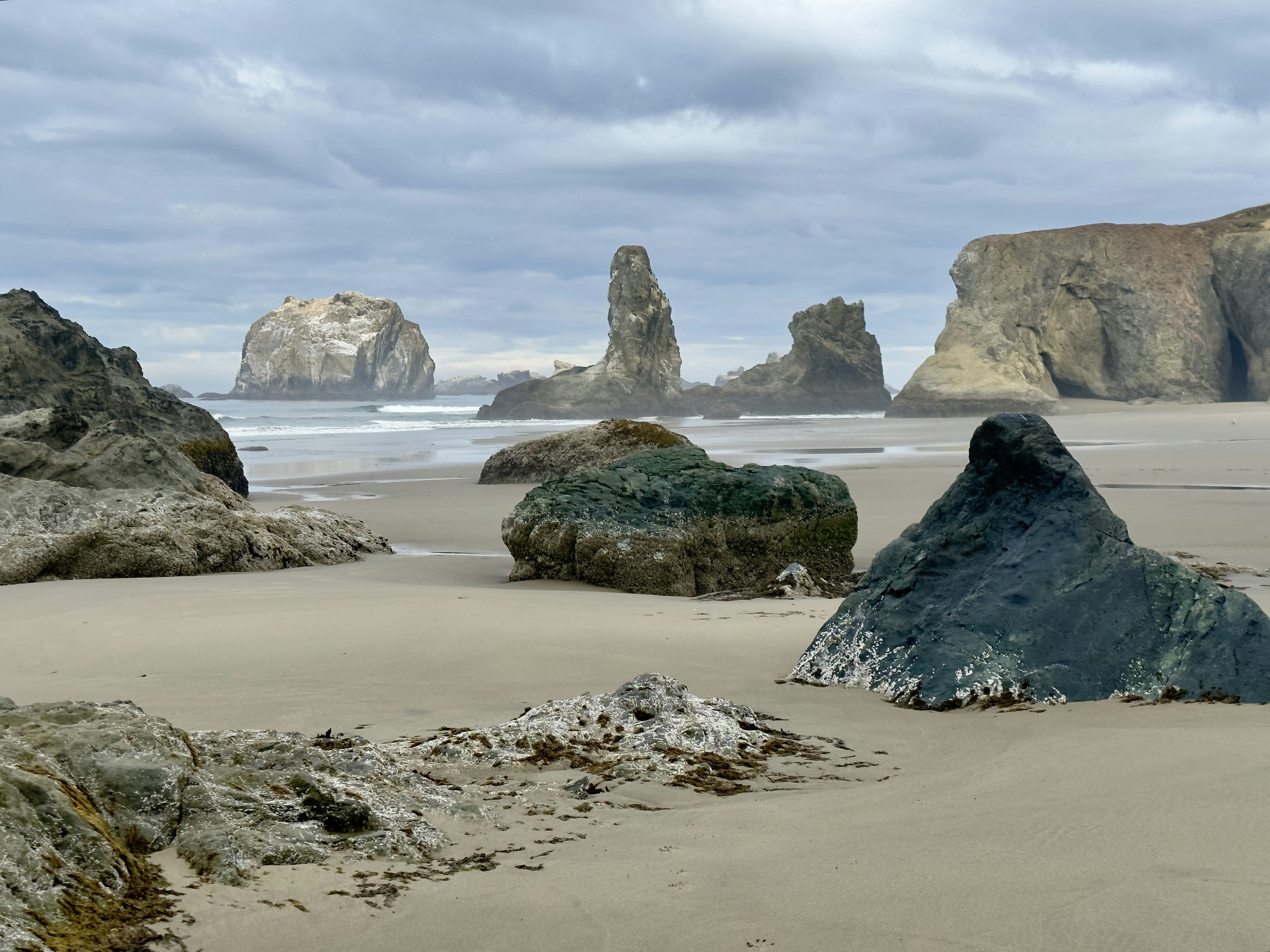 Some rocks on a beach and some water photo – Free Bandon beach Image on ...