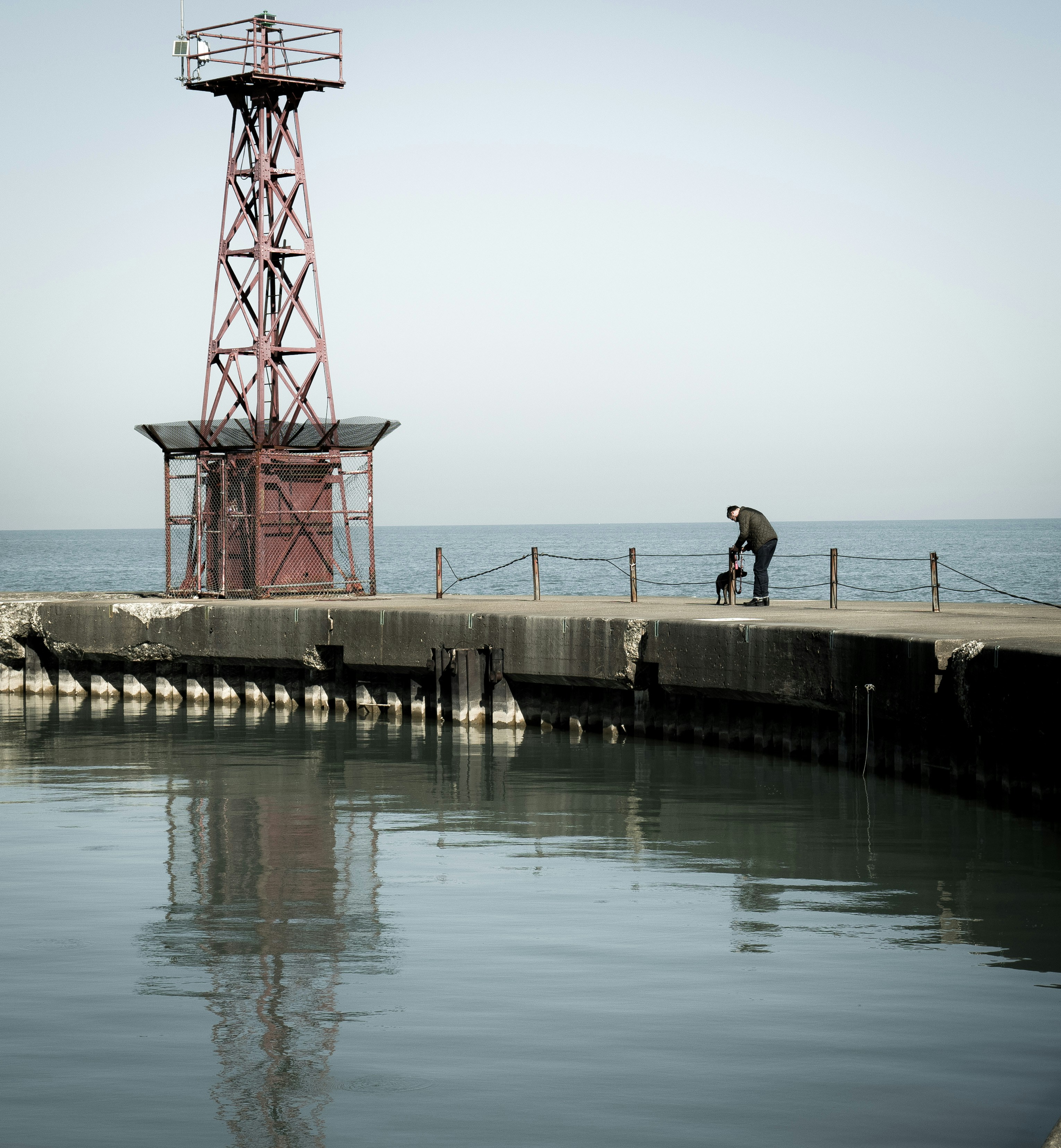 Un homme debout sur une jetée au bord de l’océan photo – Photo Front de ...