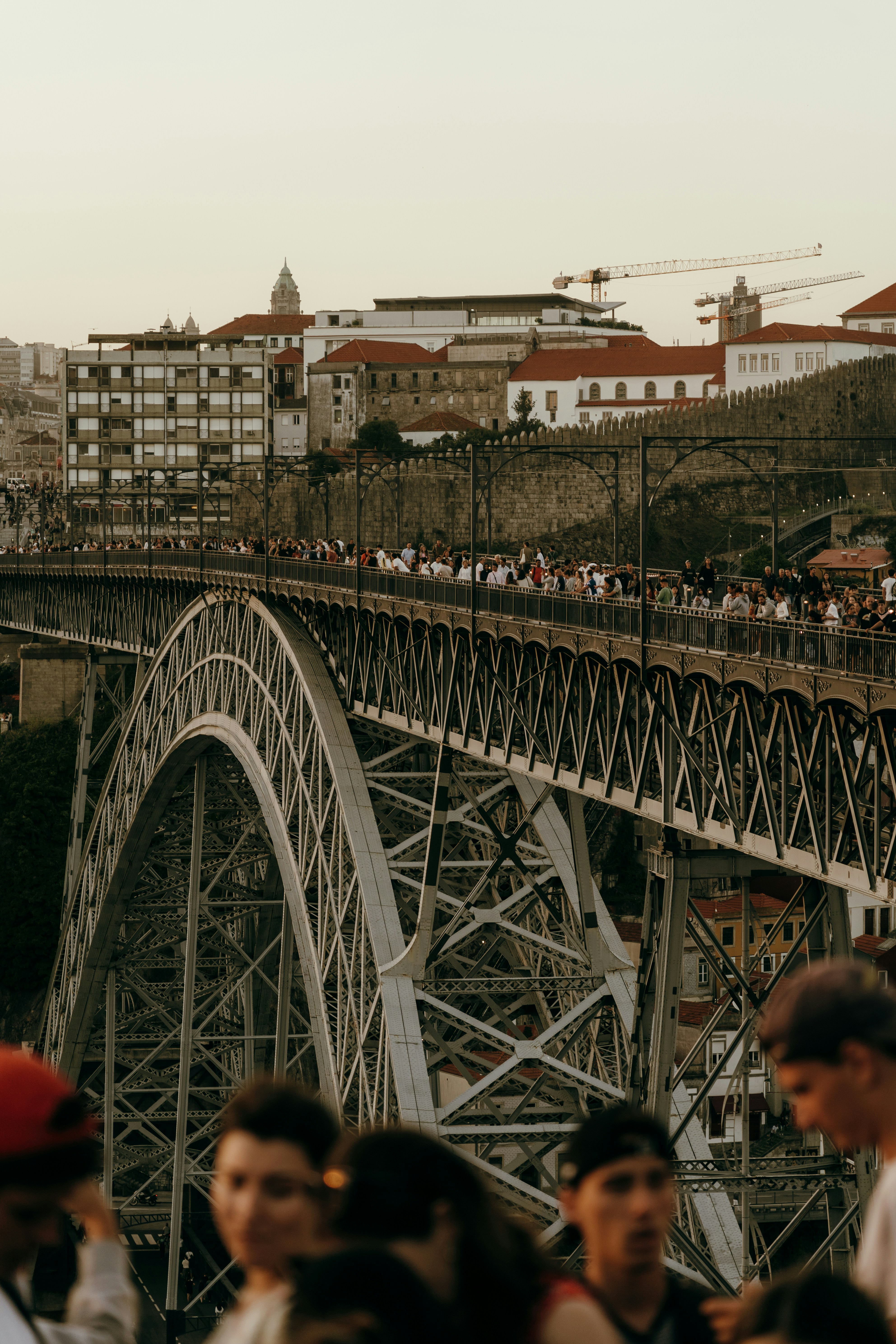 Porto's Iron Ribbon: Crowds Thread the Dom Luís I Bridge at Dusk