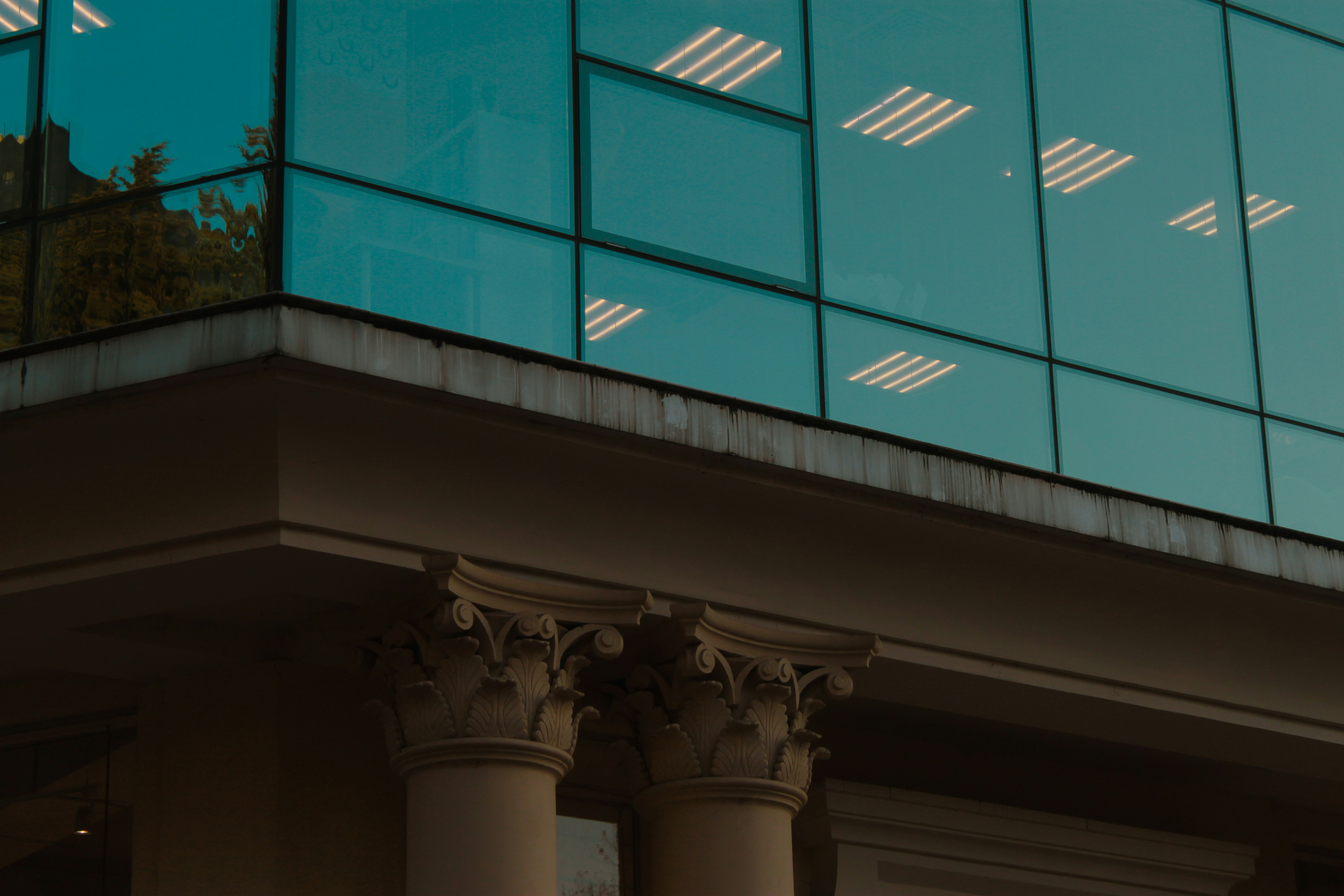 Teal Glass Facade Above Classical Columns