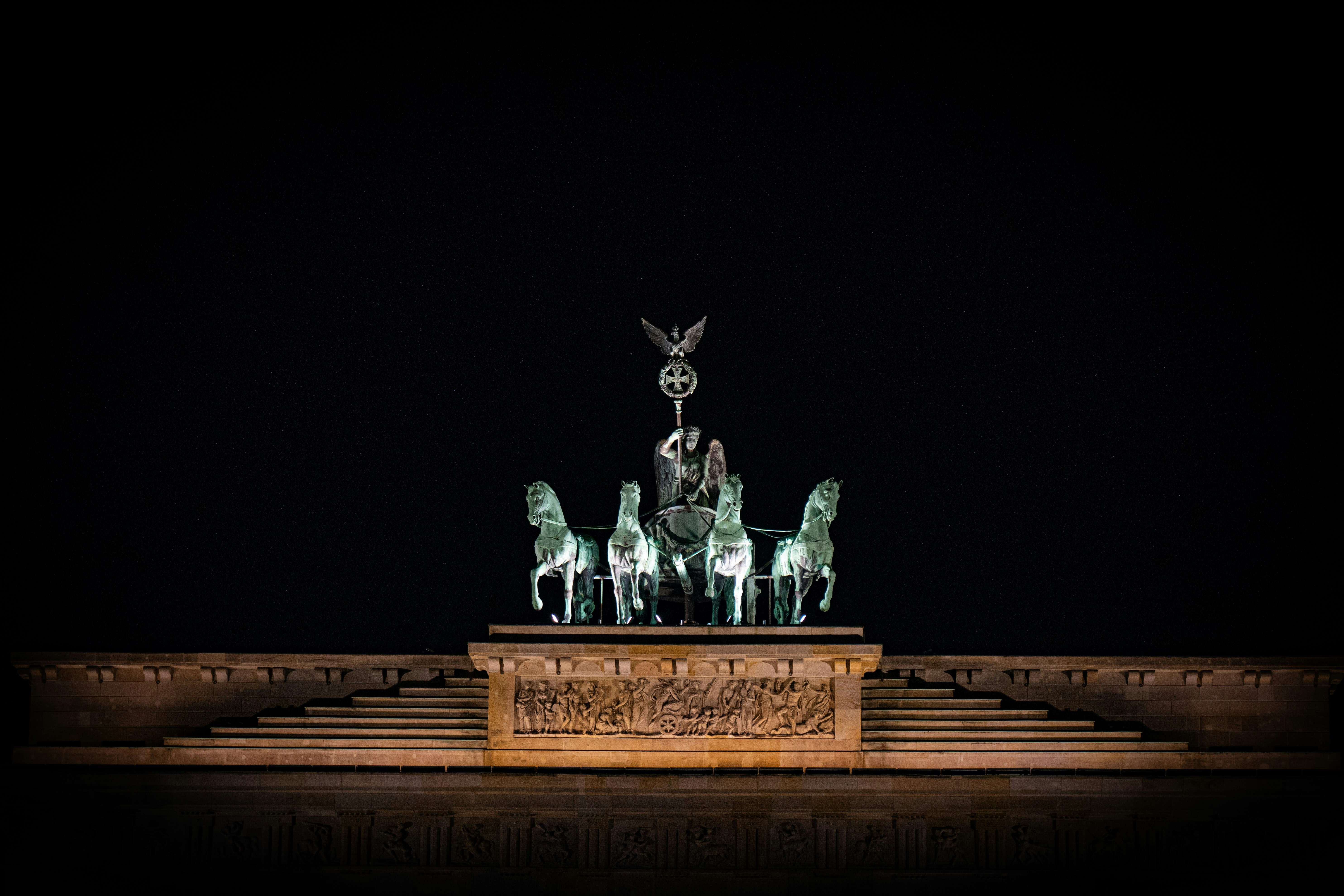 Moonlit Quadriga Over a Carved Pedestal