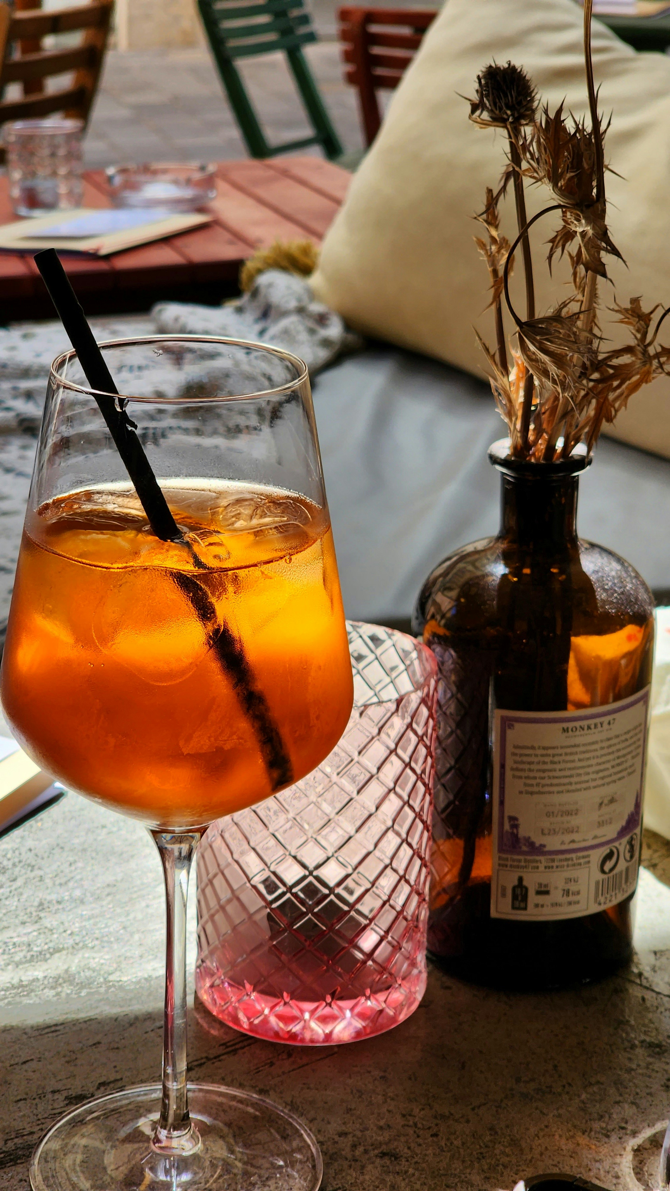 Patio Amber: A Sunlit Cocktail Beside Dried Botanicals