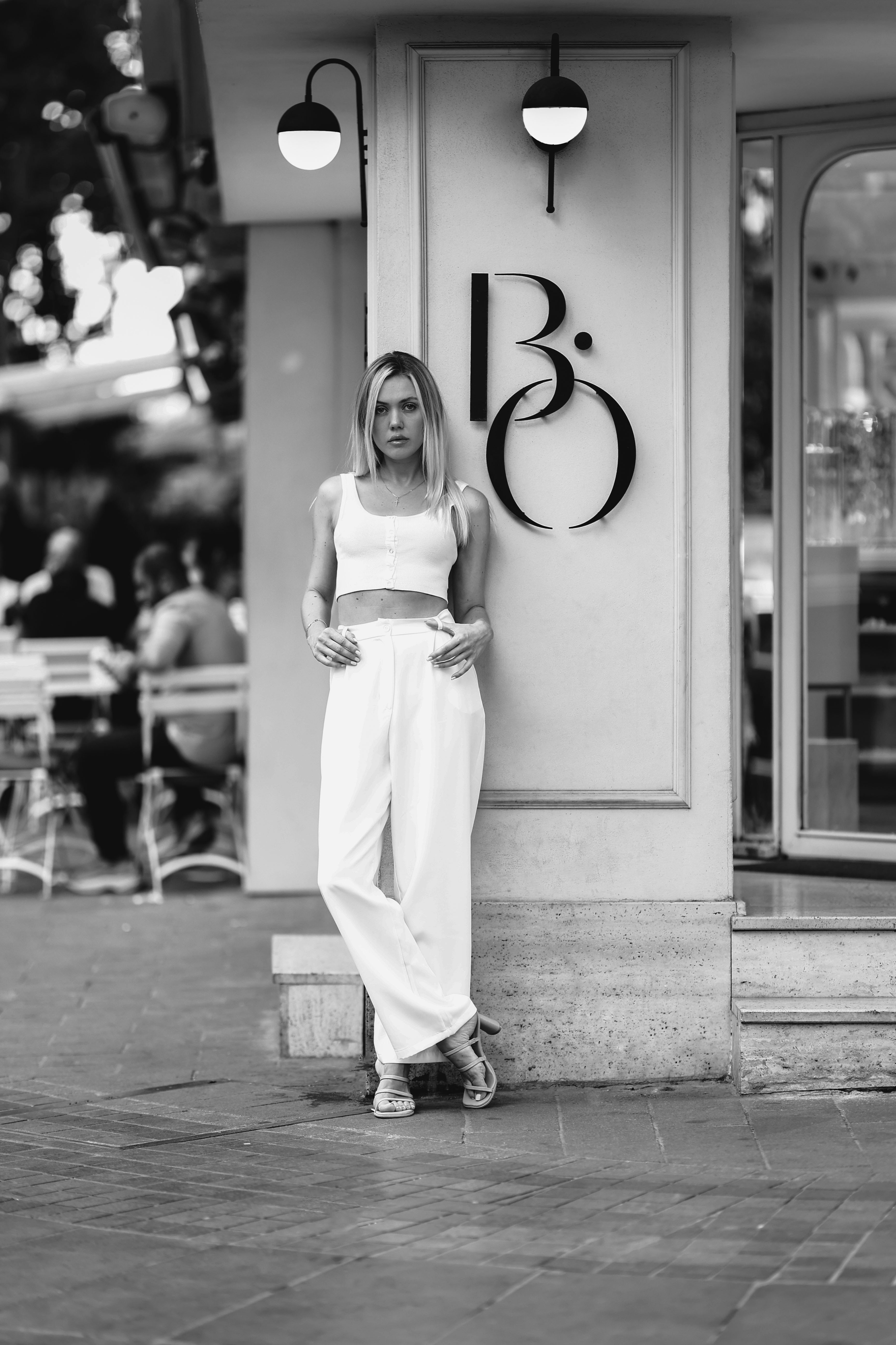 Monochrome Moment: A poised figure beside a stylish emblem