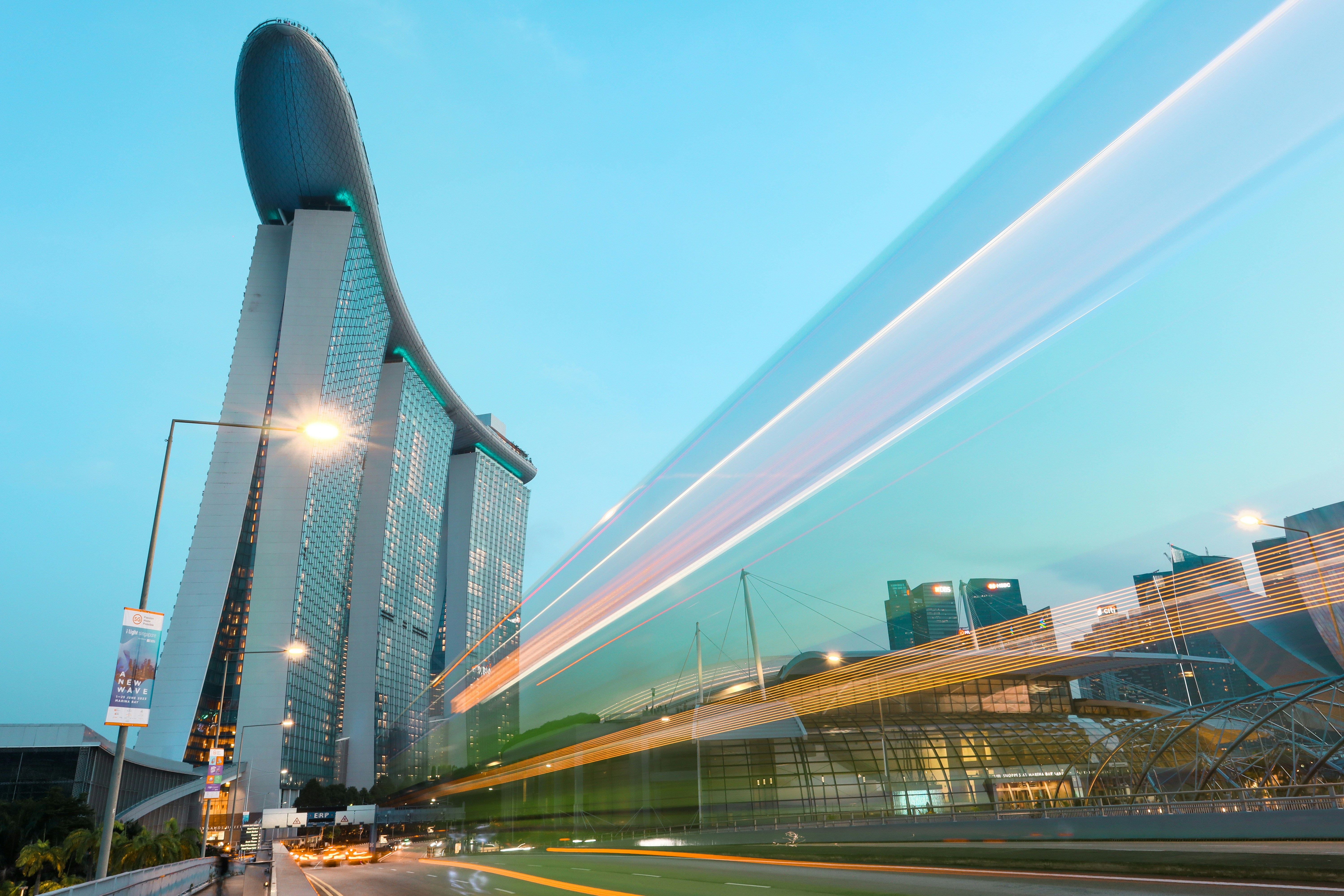 Ribboned Light Around a Glass Tower in a Modern Cityscape