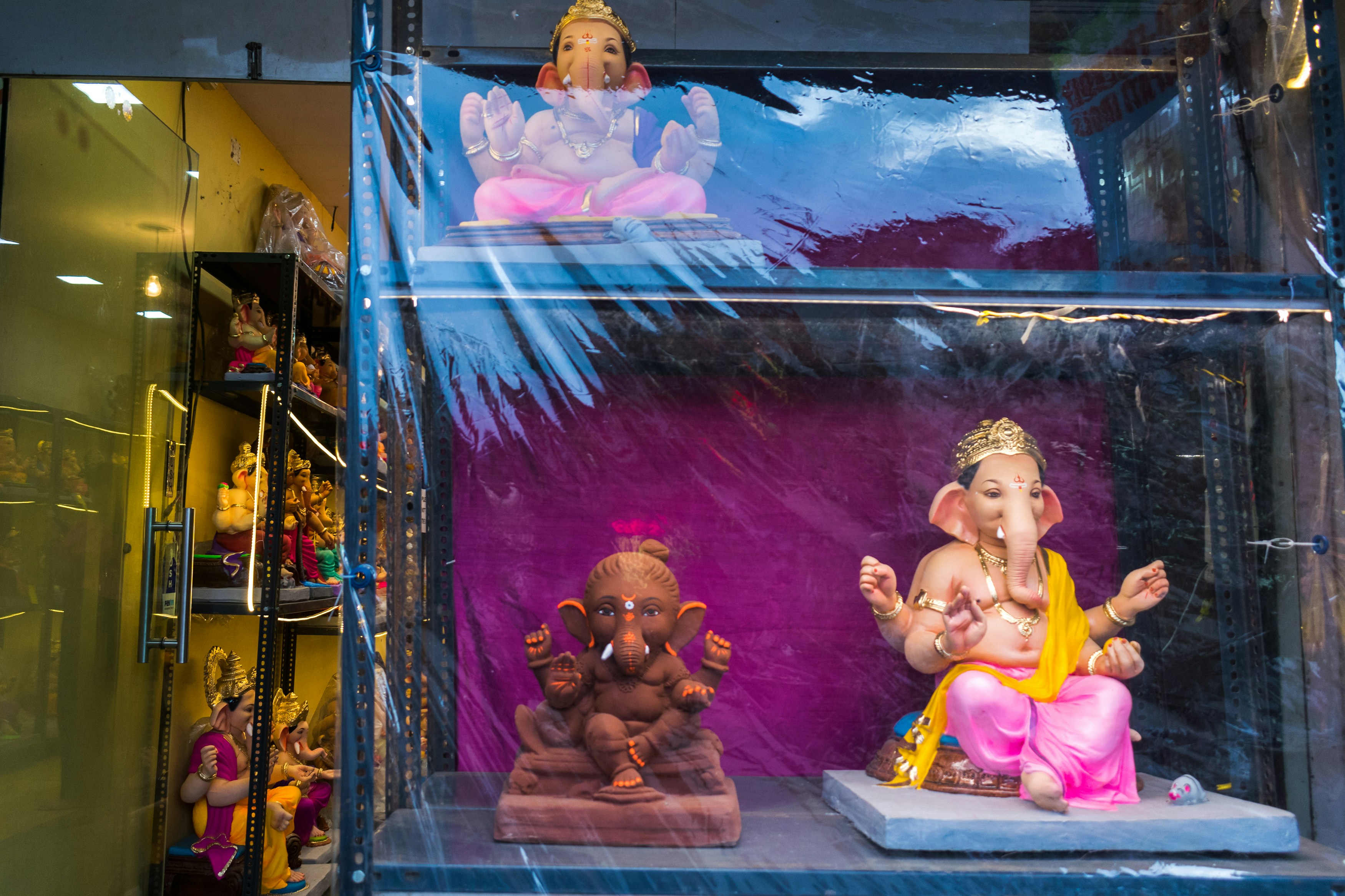 A display case filled with statues of hindu deities photo – Free Mumbai ...
