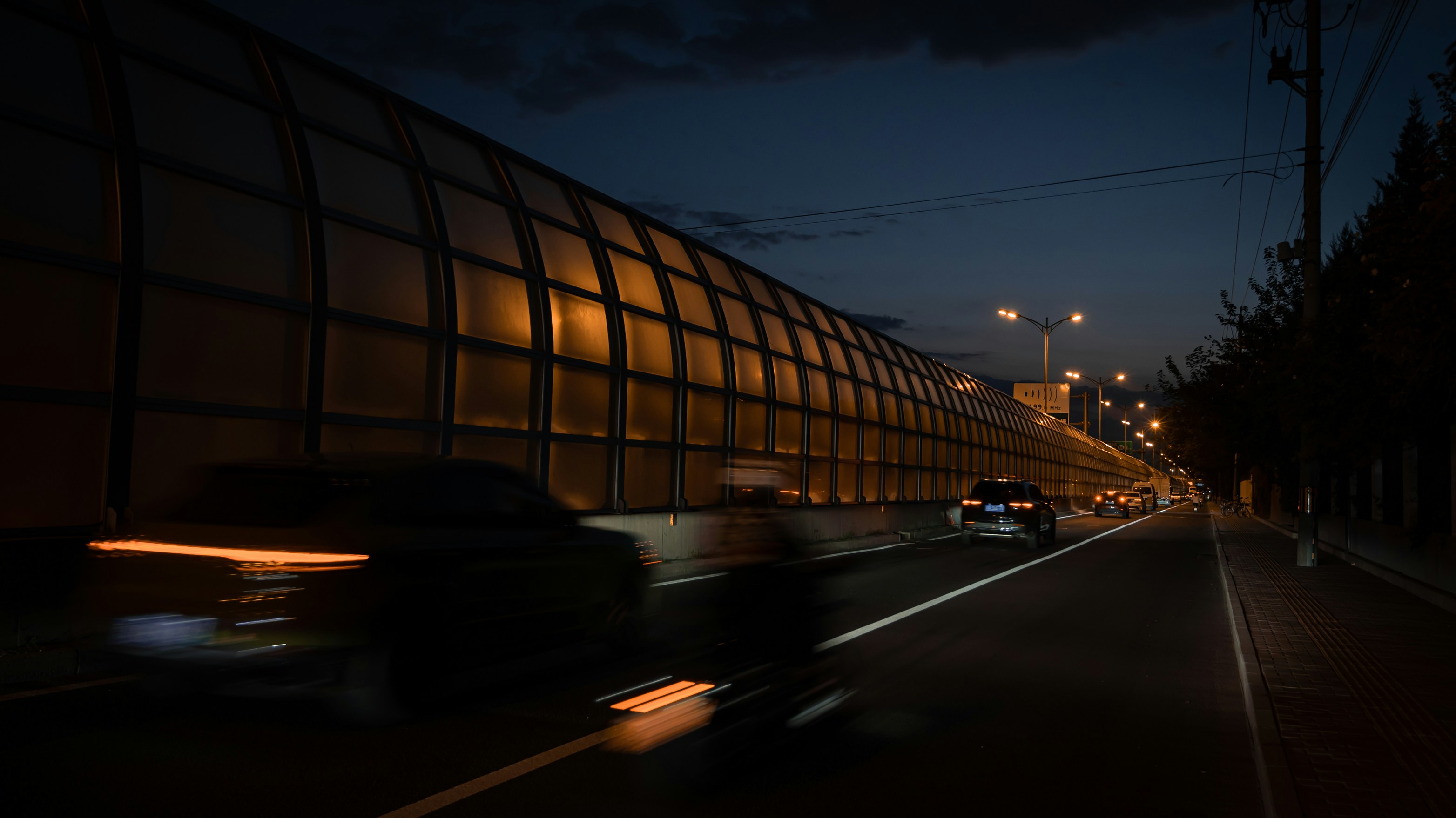 Night Arc Corridor: Long-Exposure Through a Glowing Barrier
