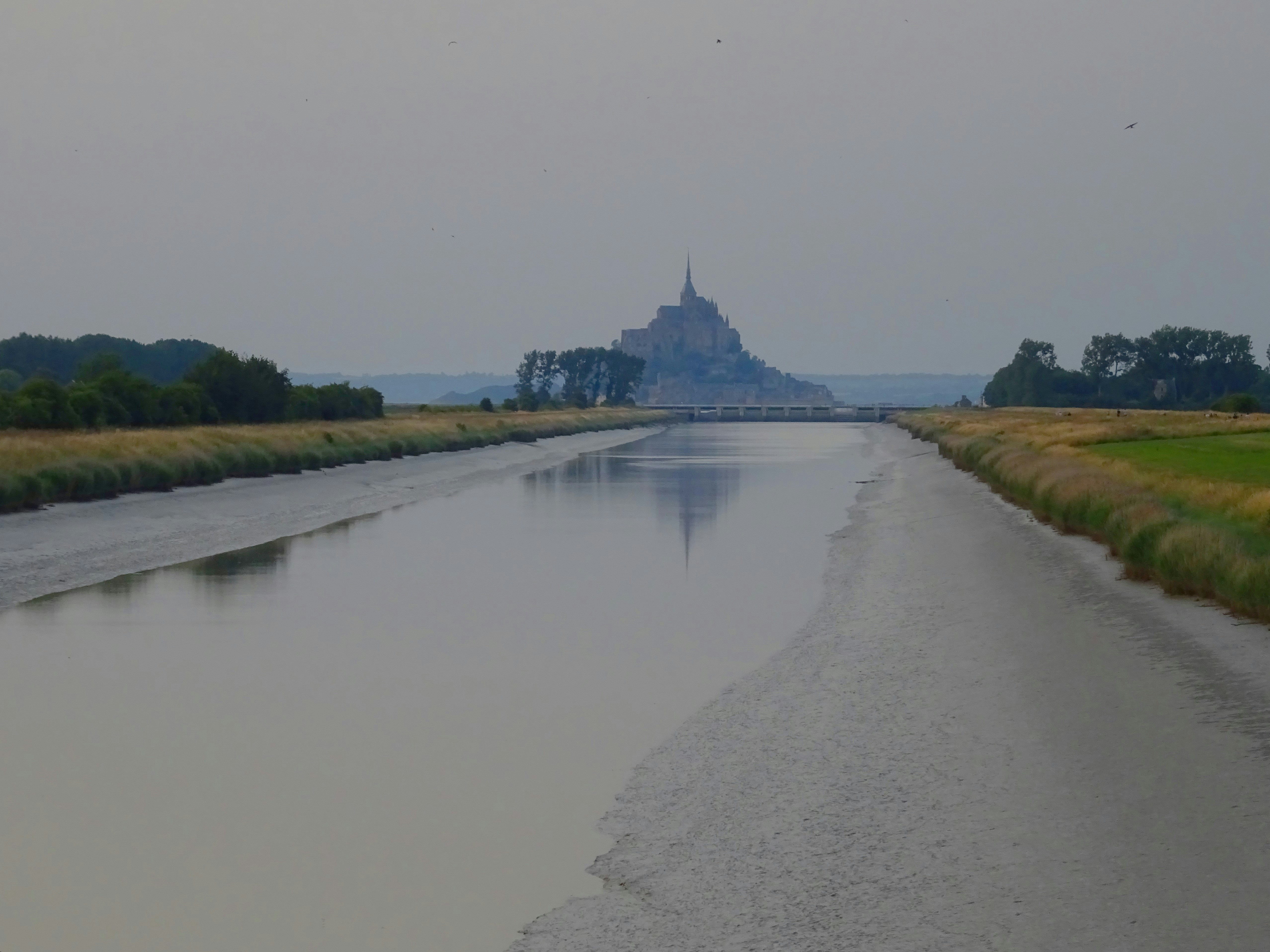 Misty Toward Cenotaph: A Distant Castle Piercing the Canal Horizon
