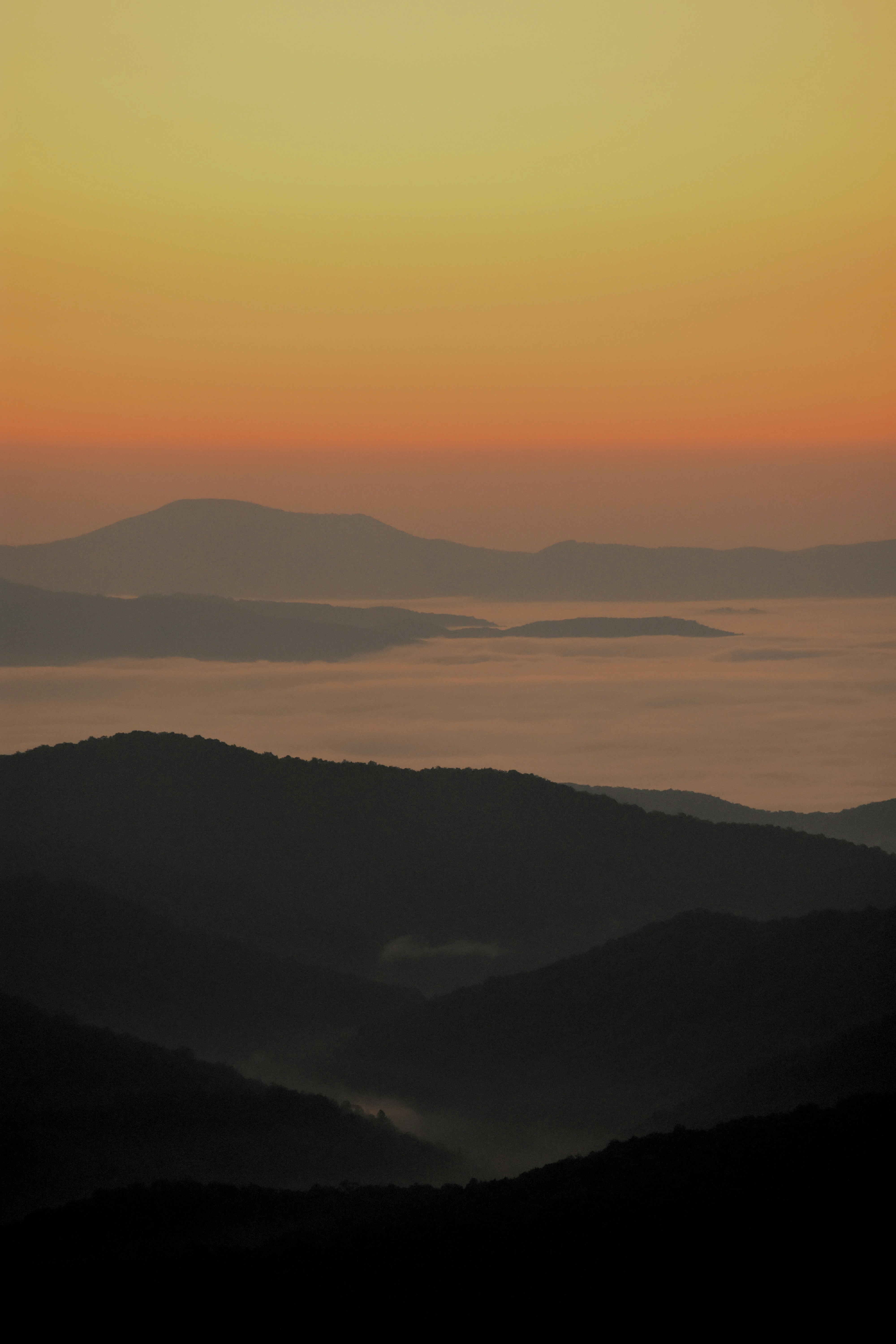 Dawn Over a Sea of Mist: Layered Ridge Silhouettes