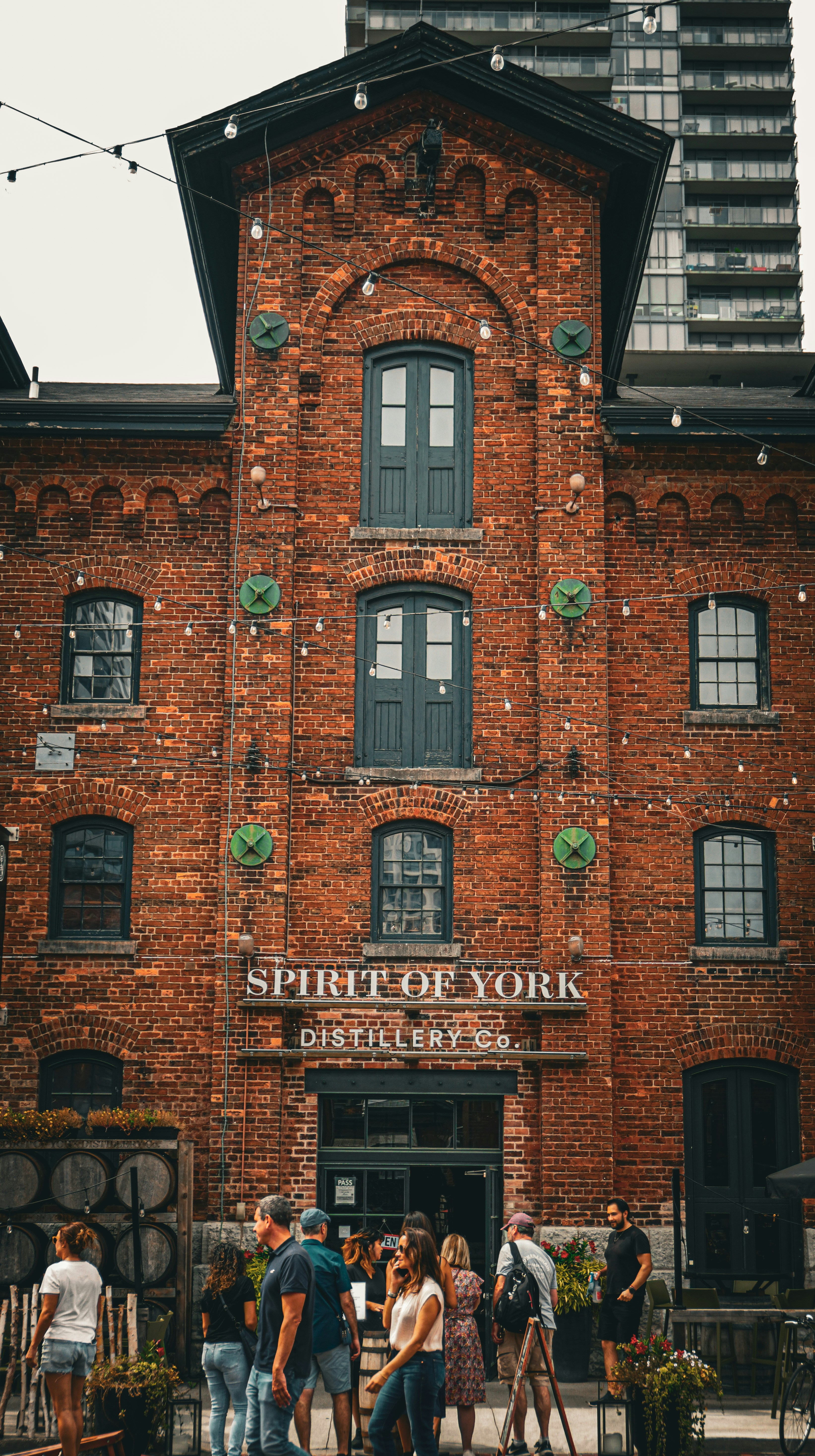 Brick Landmark at Spirit of York Distillery Co. with Courtyard Crowd