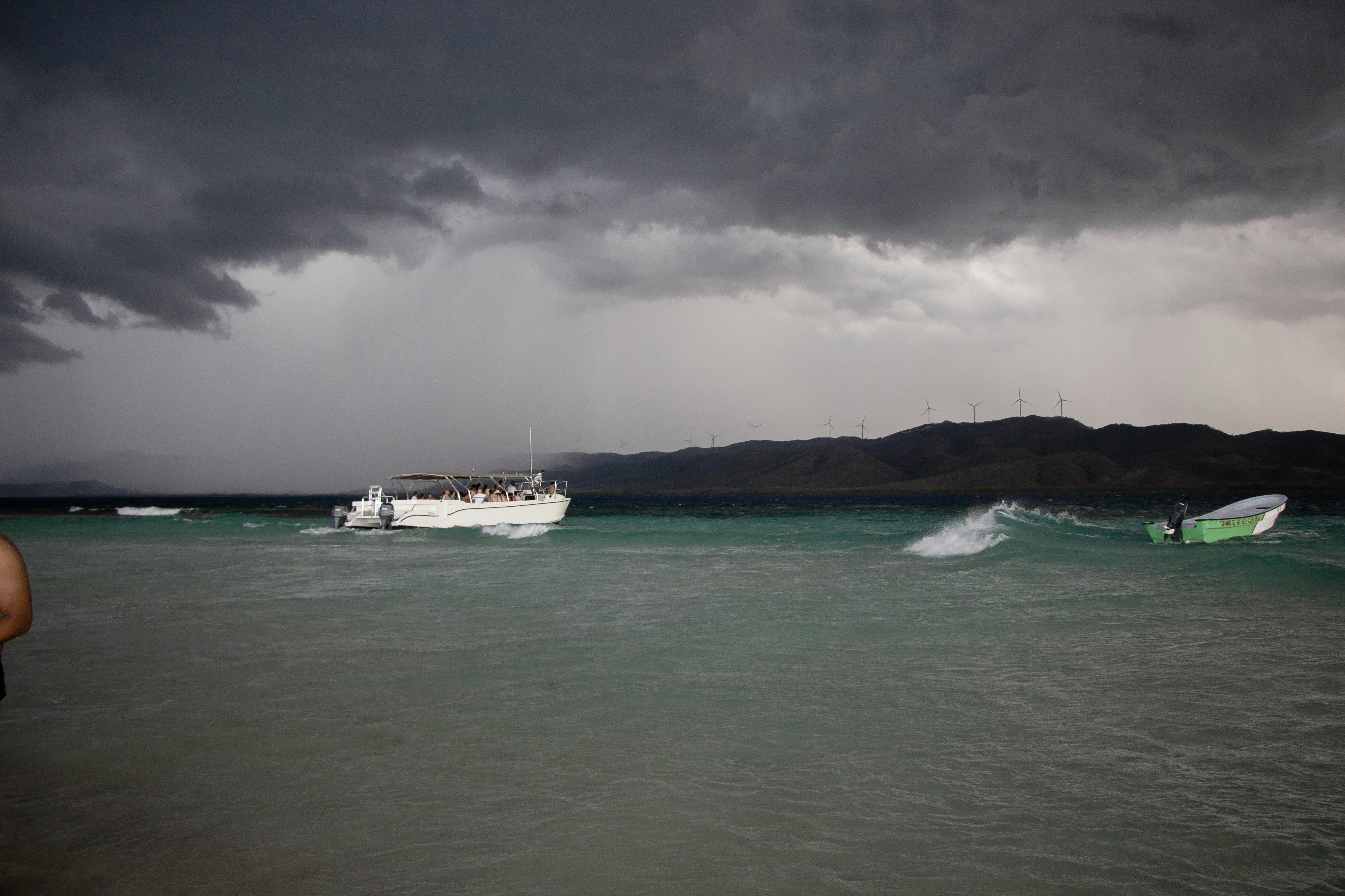 White Vessel Amid Turquoise Seas Under a Looming Storm
