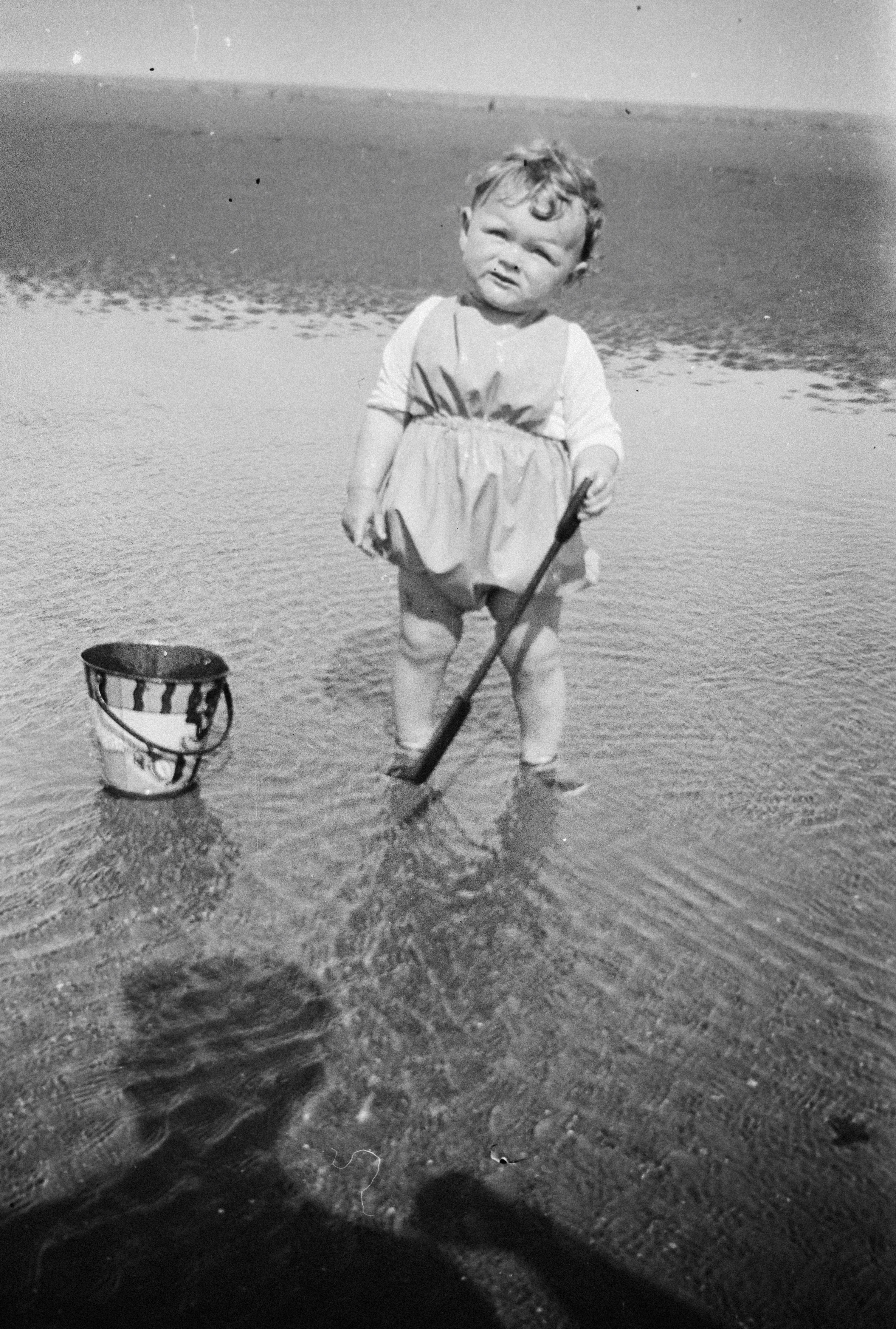Tiny Gardener at the Tide: A Beachfront Portrait of Curious Stillness