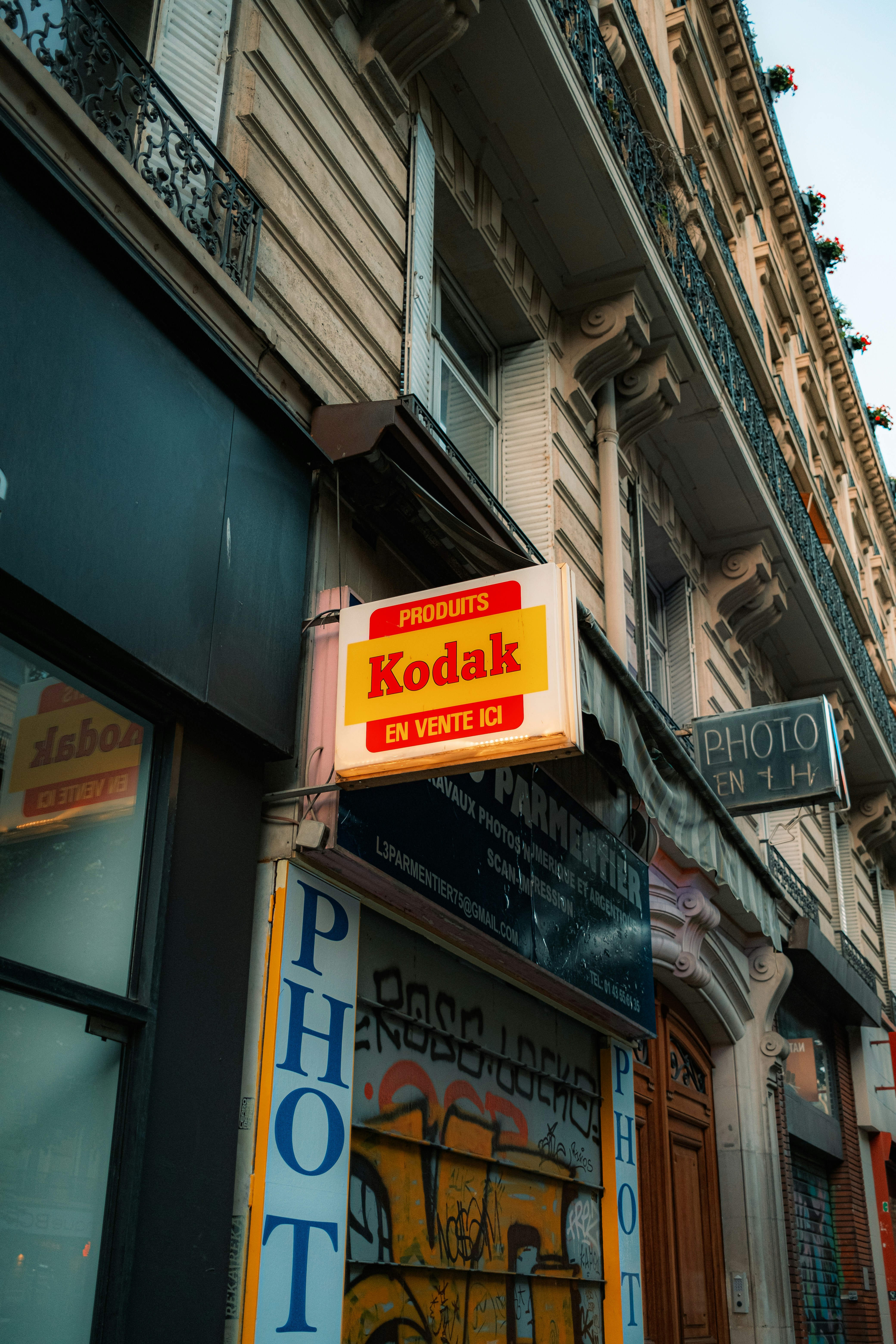 A kodak store on the corner of a city street photo – Free Building ...