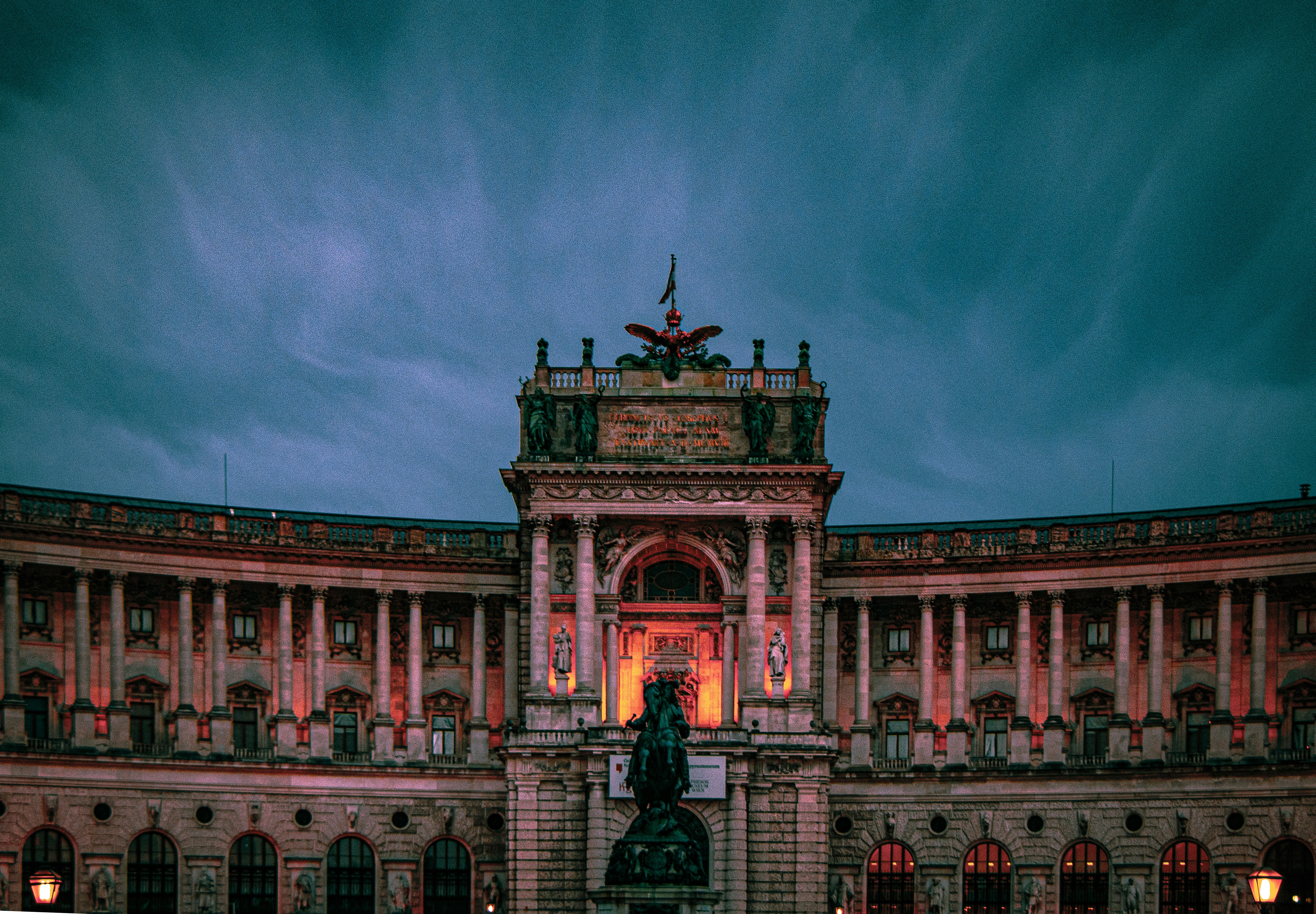 Ember-Lit Central Statue Framed by a Grand Arcade at Dusk