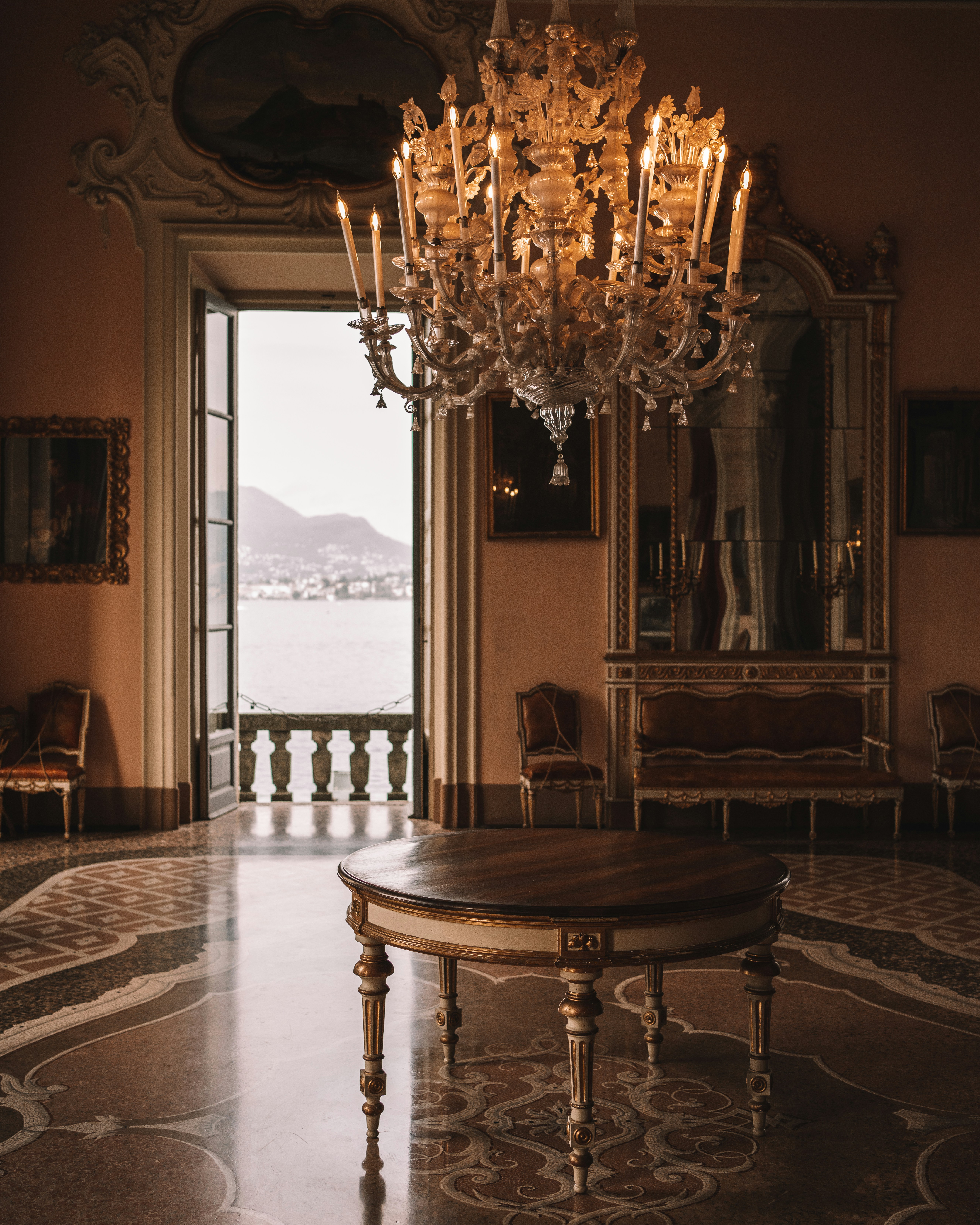 Crystal Chandelier at Dusk: A Lavish Salon Framing a Lakefront View