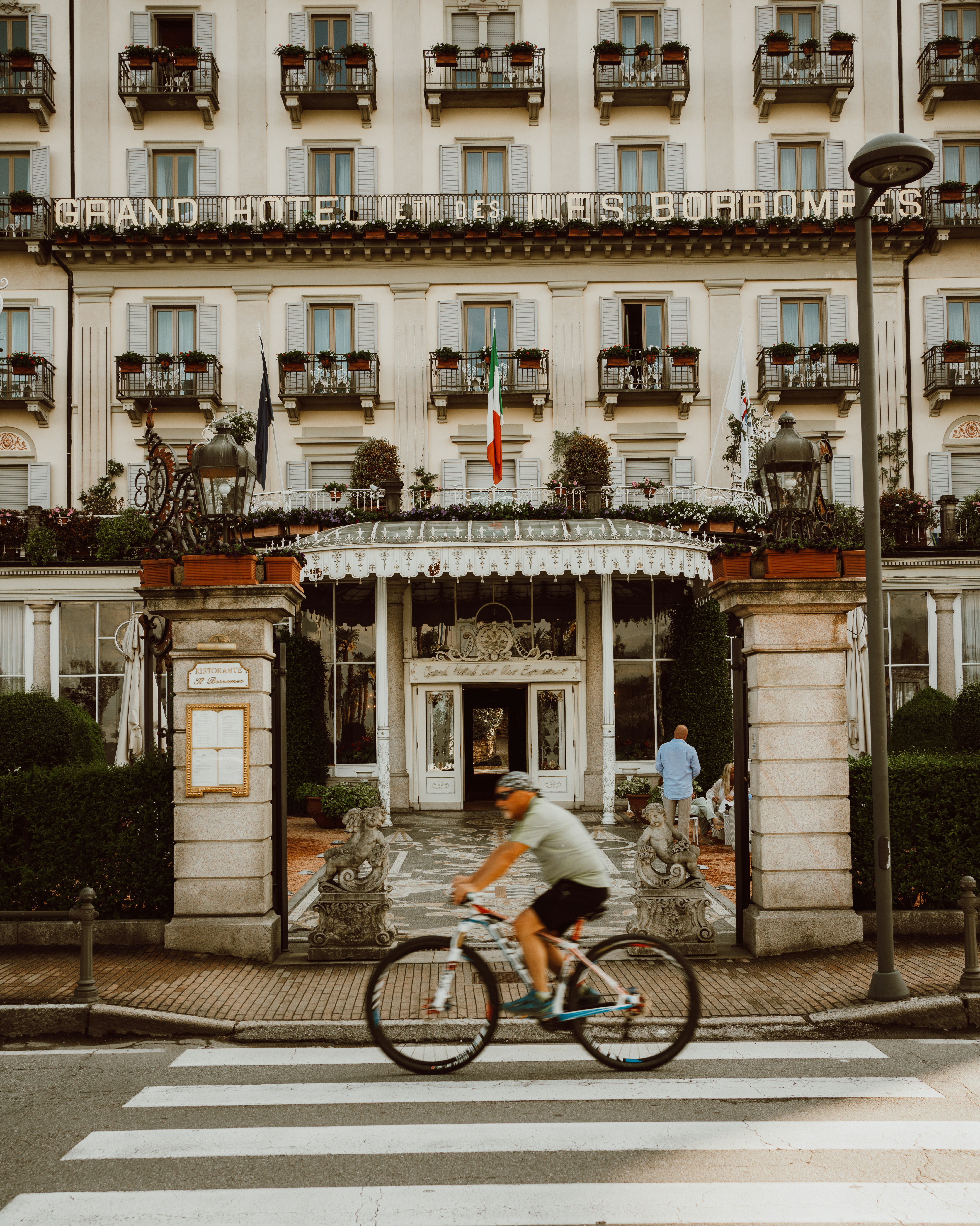 Cycle past the Grand Entrance of a European Hotel