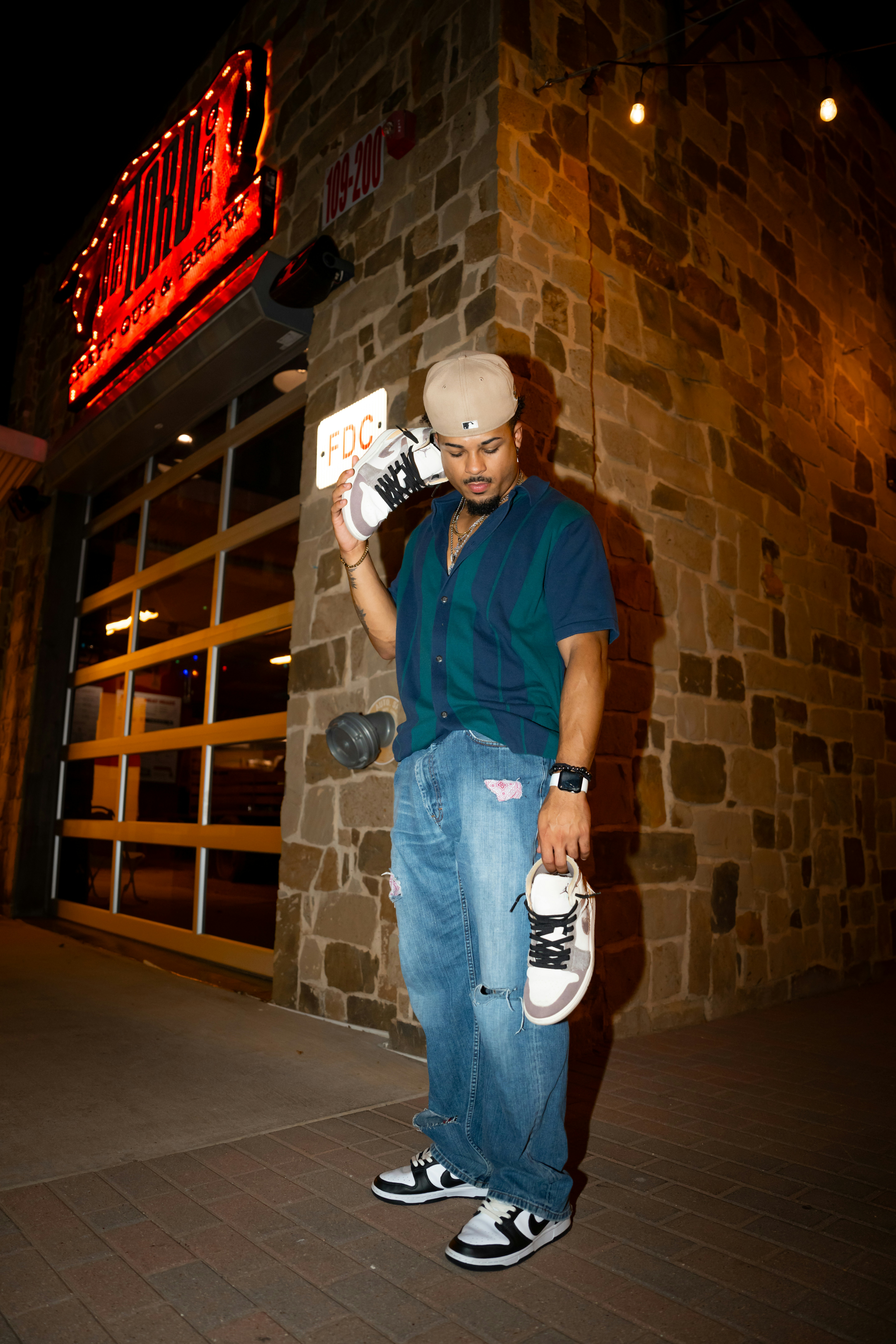Midnight Strut Outside a Brick-Front Venue