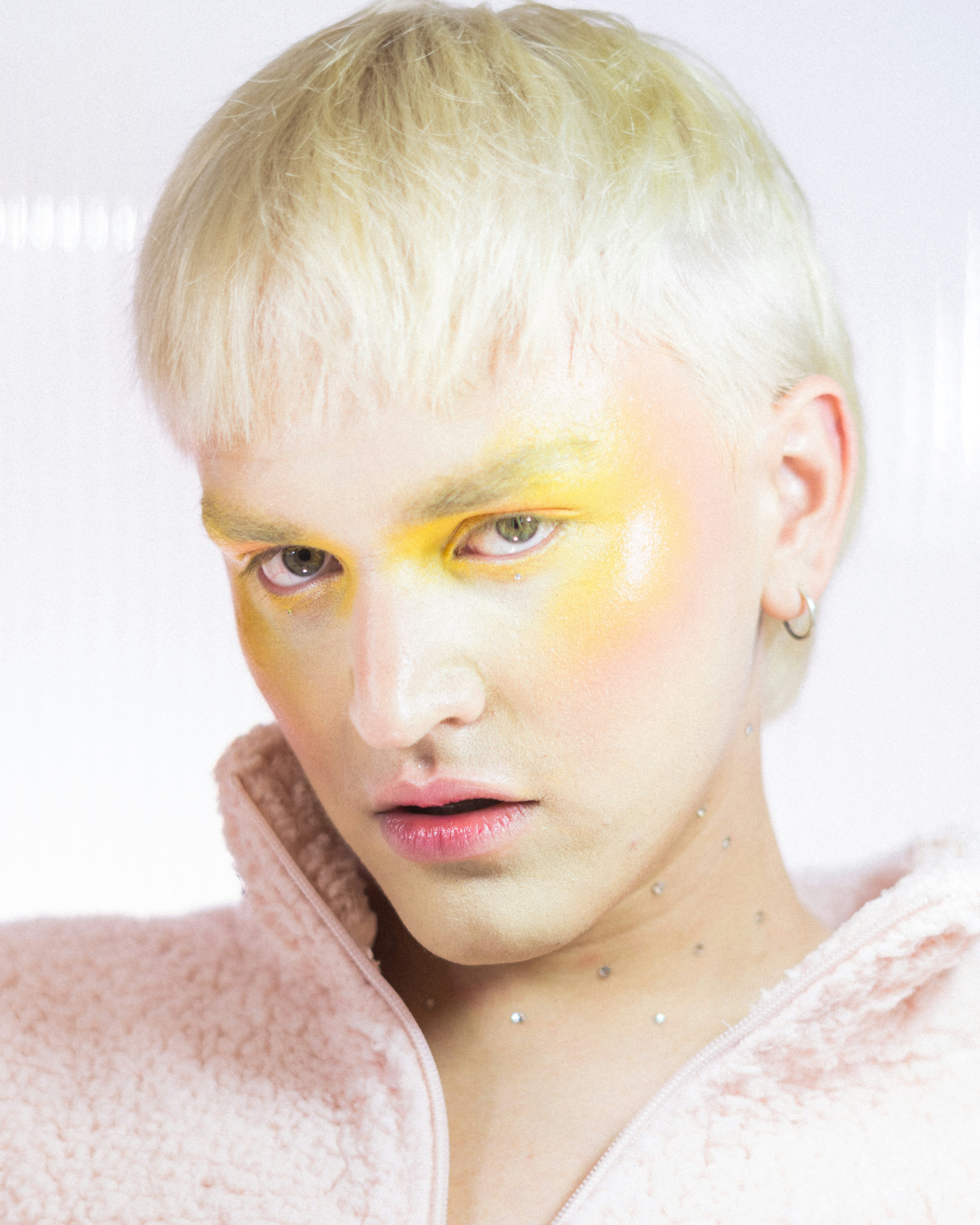 A woman with a yellow face paint on her face photo – Free Style Image ...