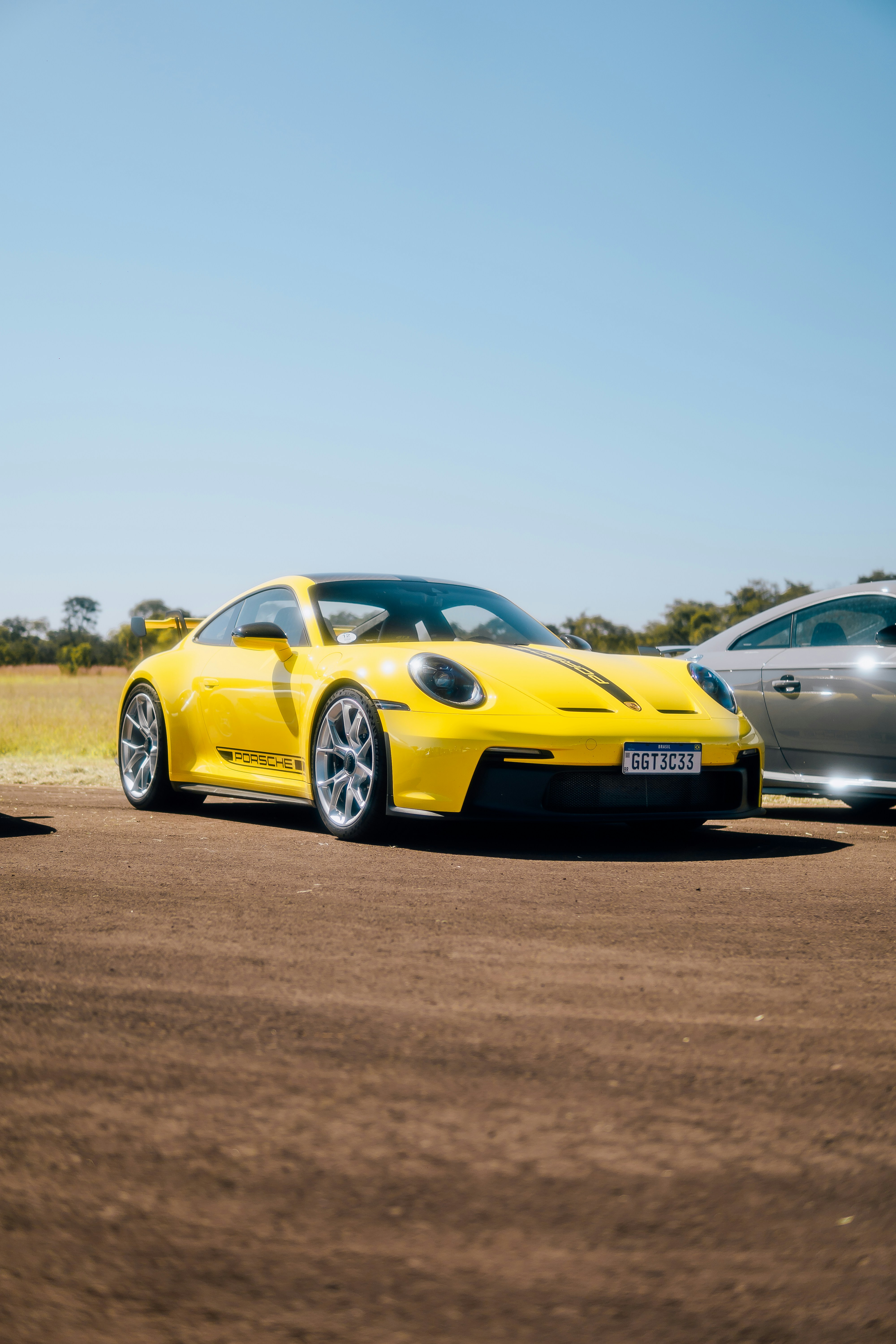Sunlit Porsche 911 Pauses on an Open Tarmac