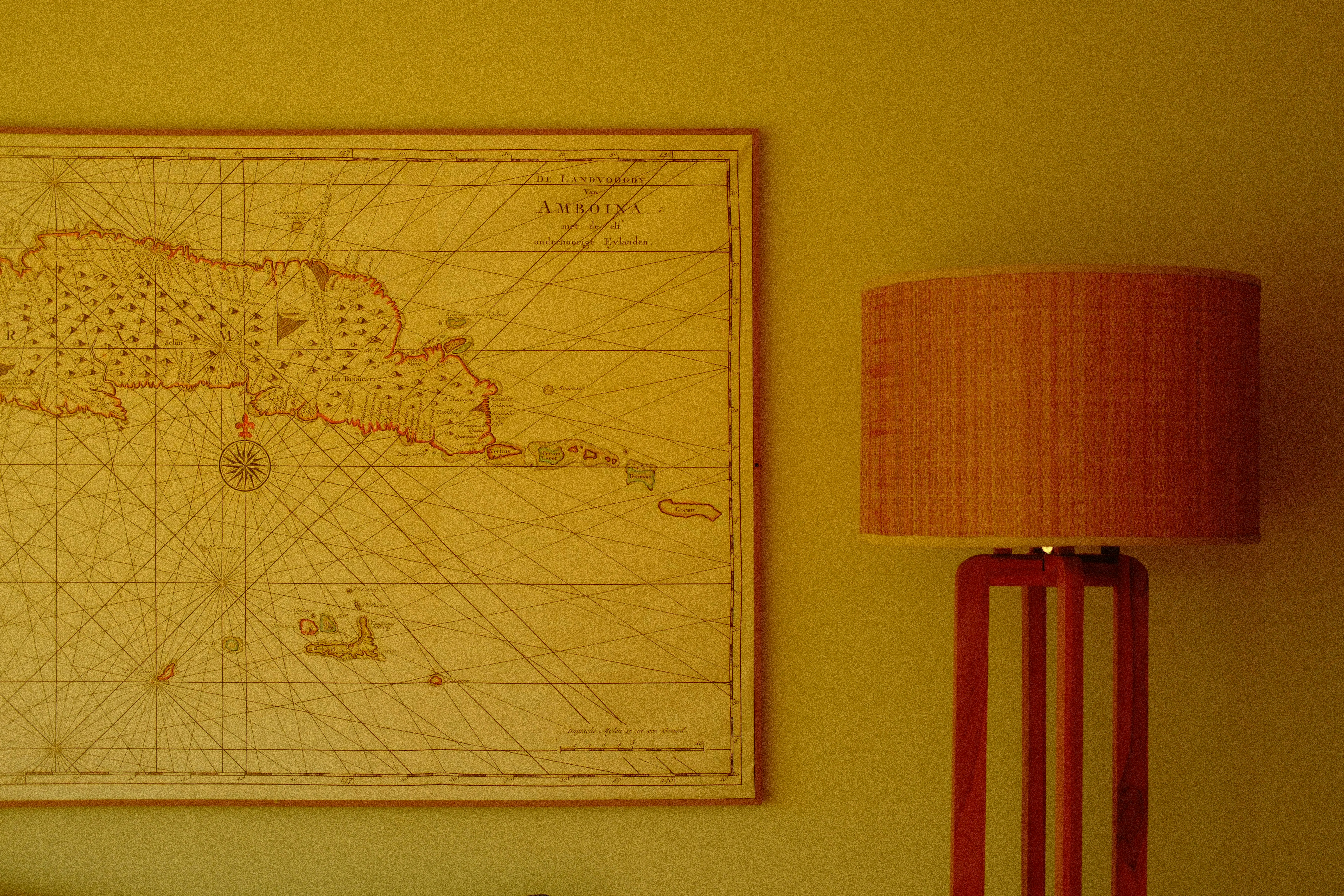 Warm Corner: A Vintage Maritime Map Bask in the Glow of a Tripod Lamp