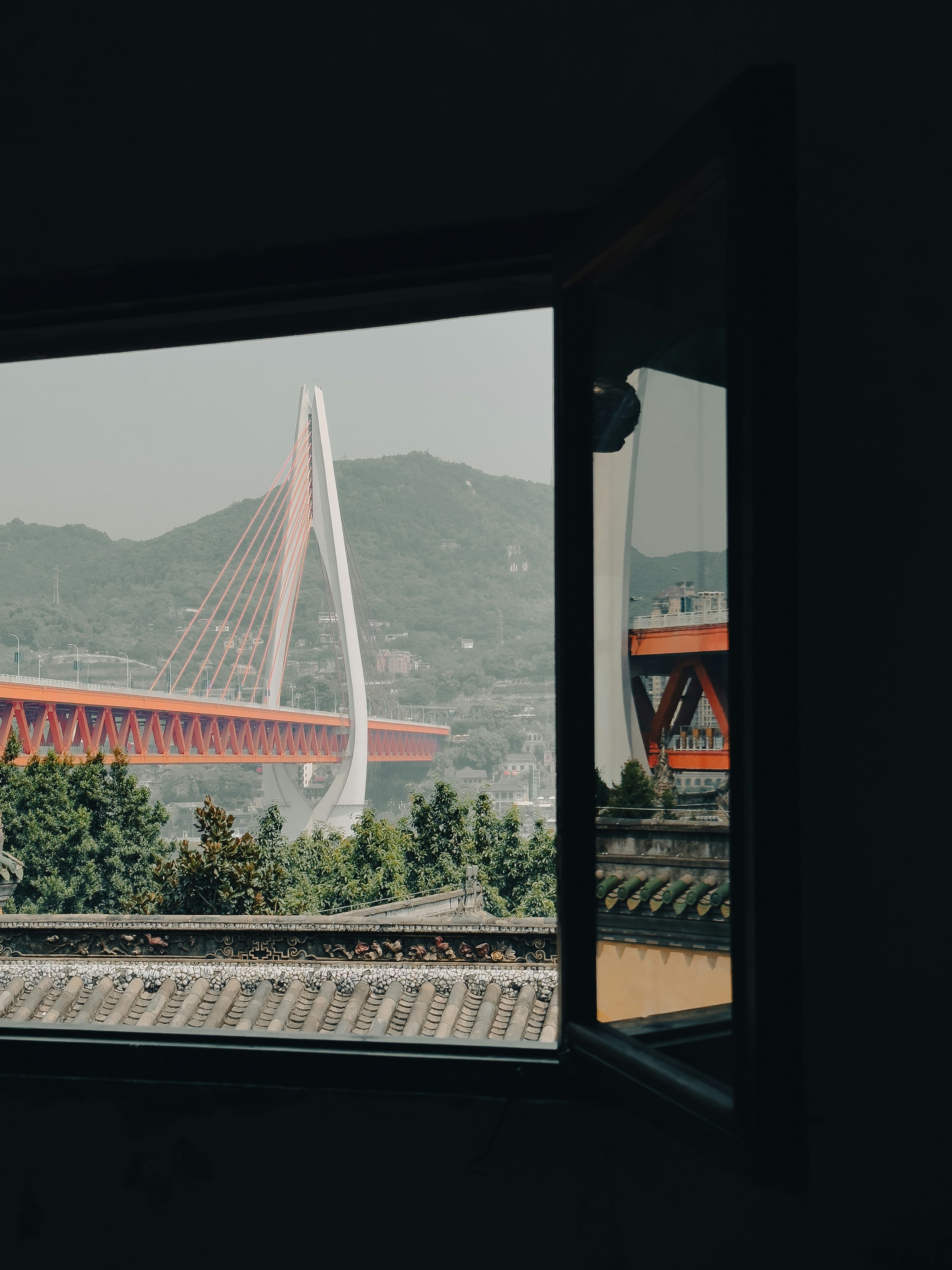 A view of a bridge through a window photo – Free Urban Image on Unsplash