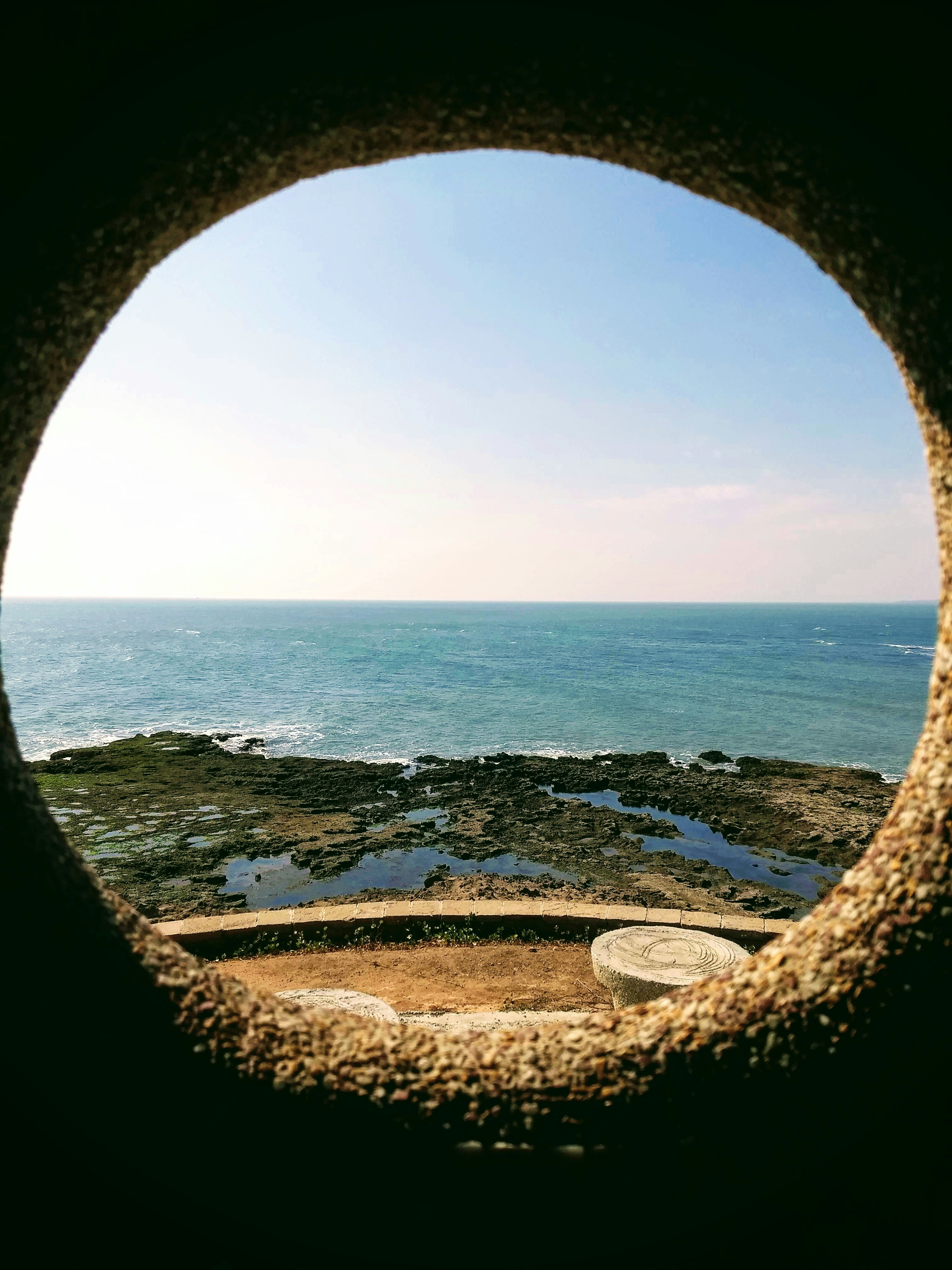 A view of the ocean through a round window photo – Free Diu Image on ...