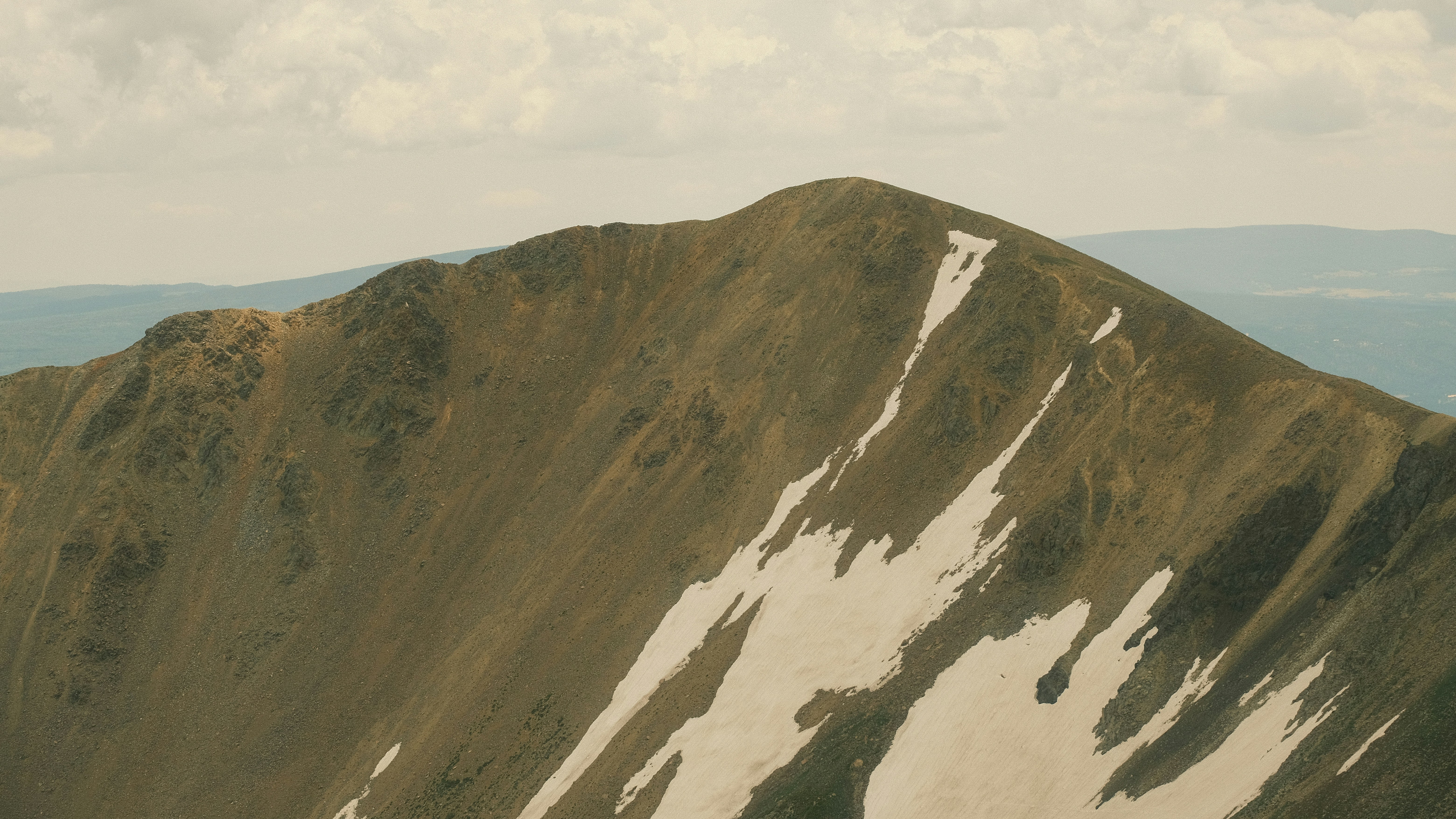 Snow-veined Ridge Against a Quiet Alpine Horizon