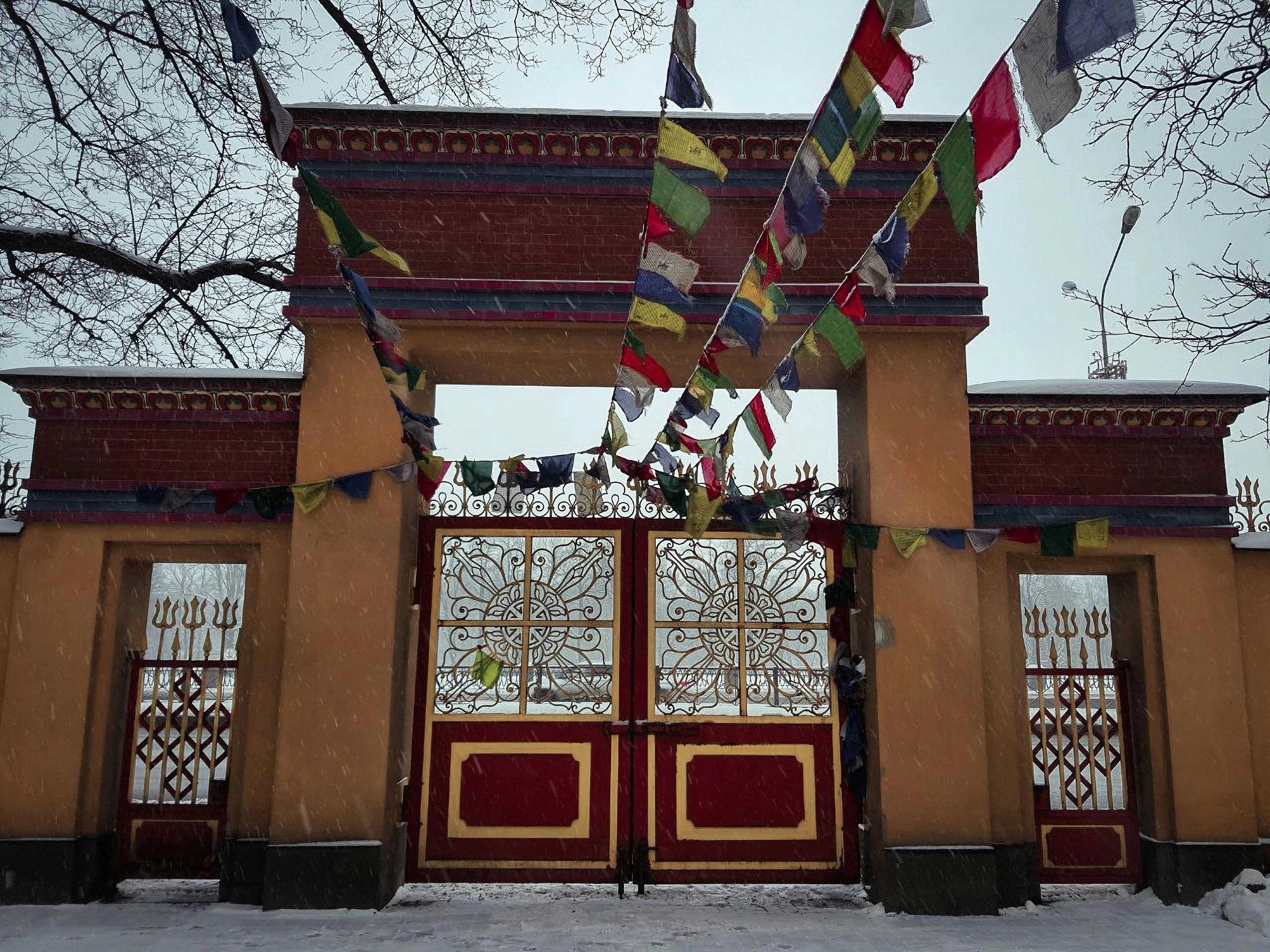 A gate with a bunch of flags hanging from it photo – Free Building ...