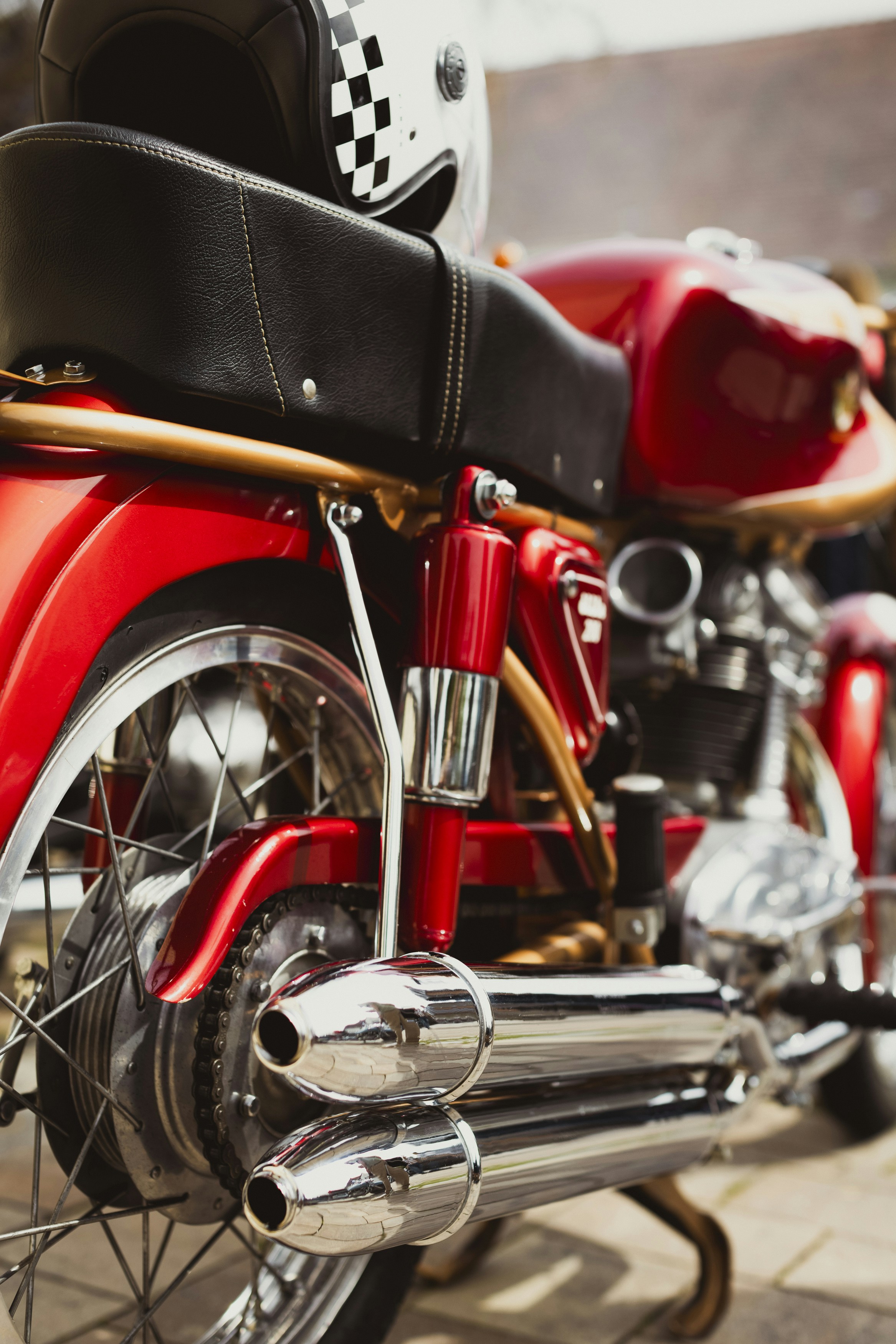 A close up of a red motorcycle with a checkered helmet photo – Free ...