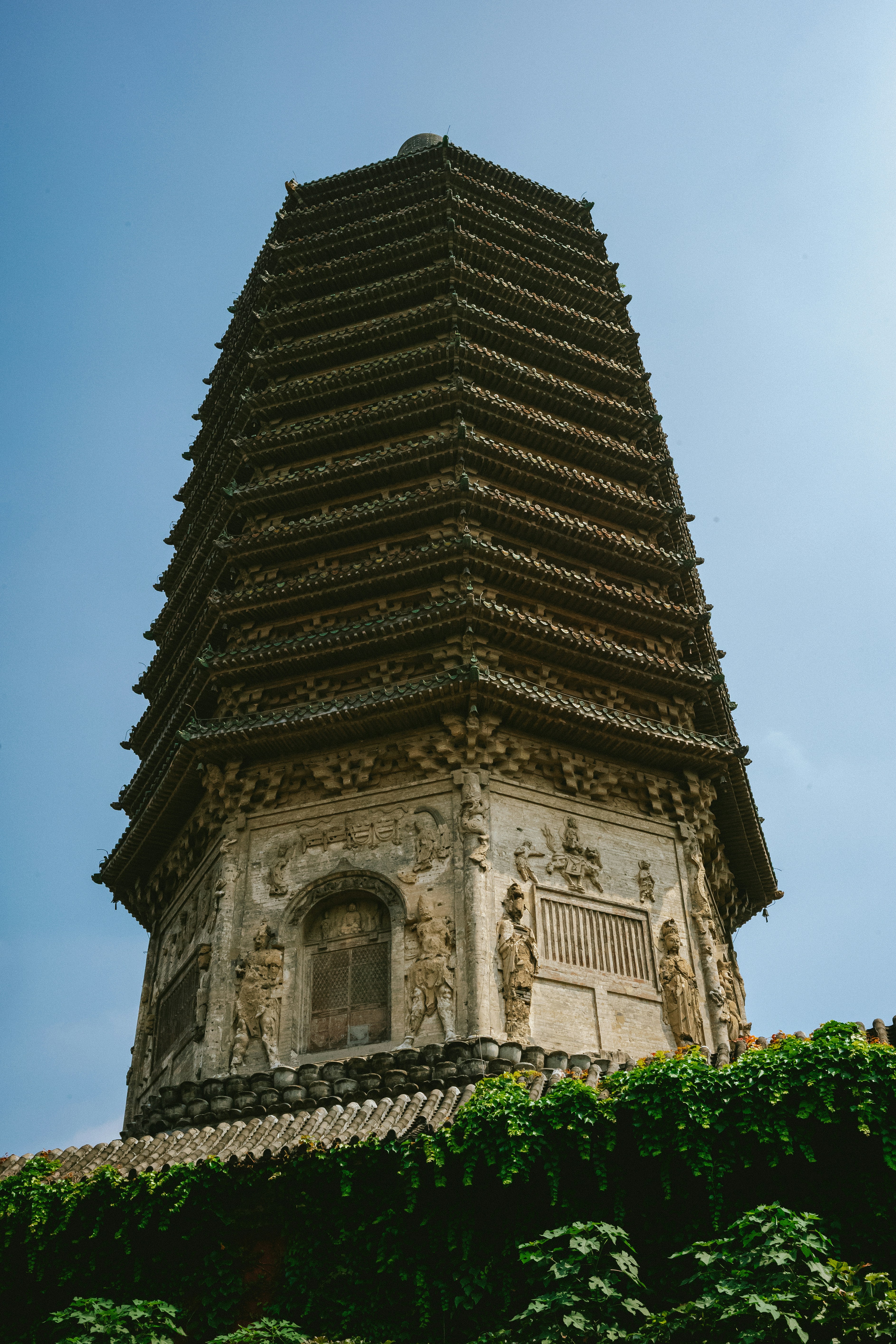Tiered Pagoda in Stone: Carved Reliefs Rise Toward a Blue Sky