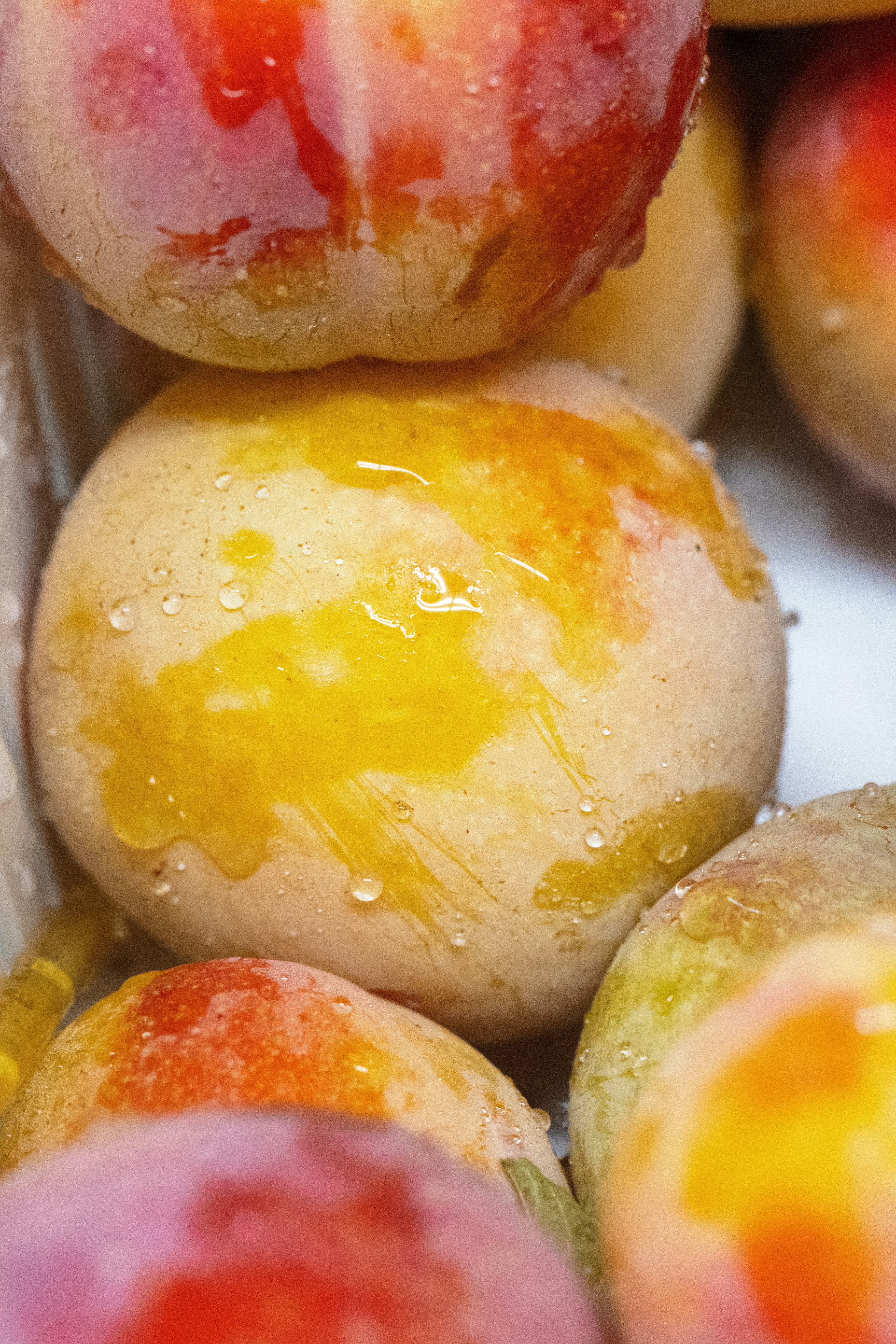 Dew-Kissed Peach Orbs in a Crate Close-Up