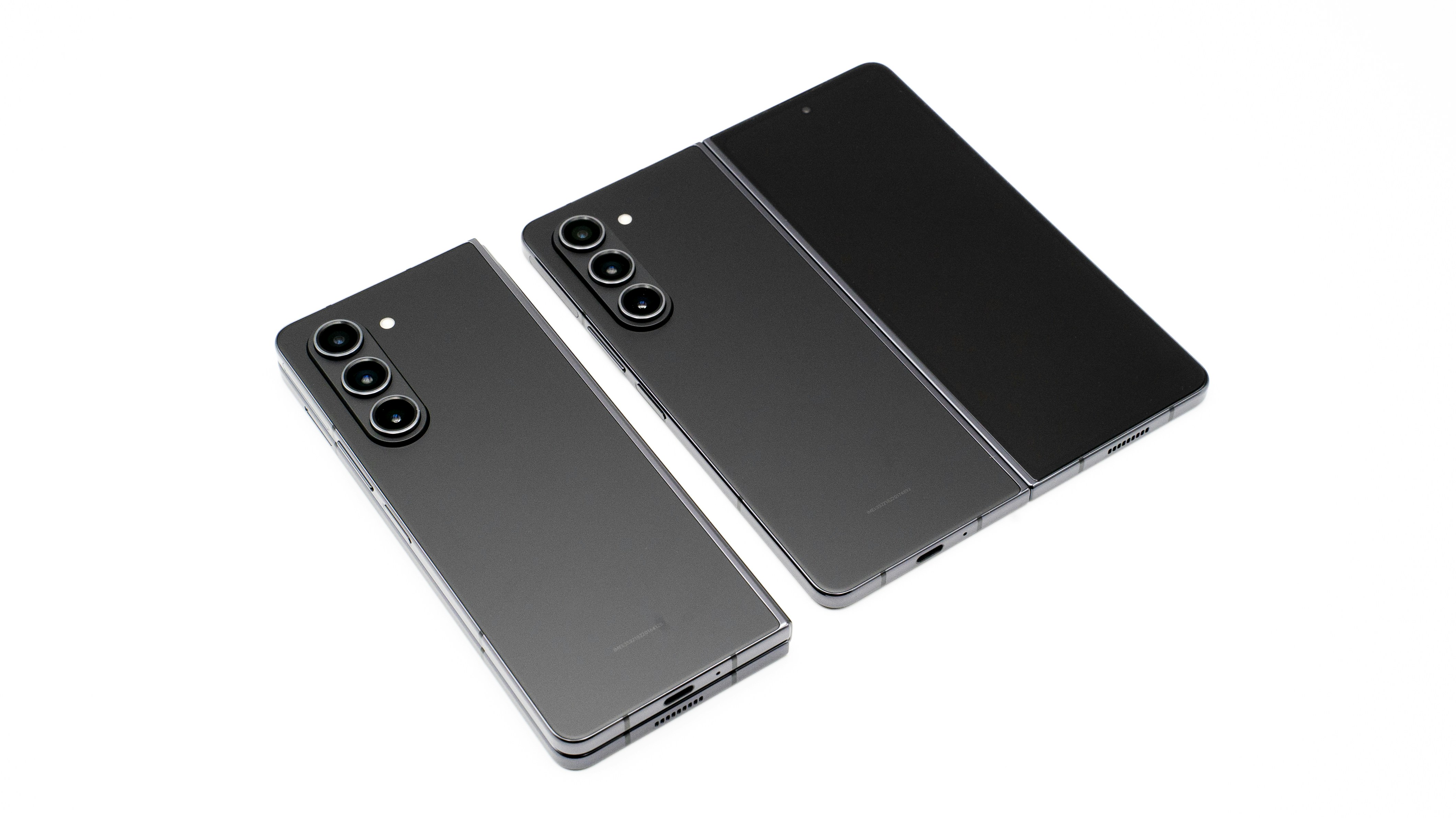 Two black cell phones side by side on a white surface photo – Free On ...