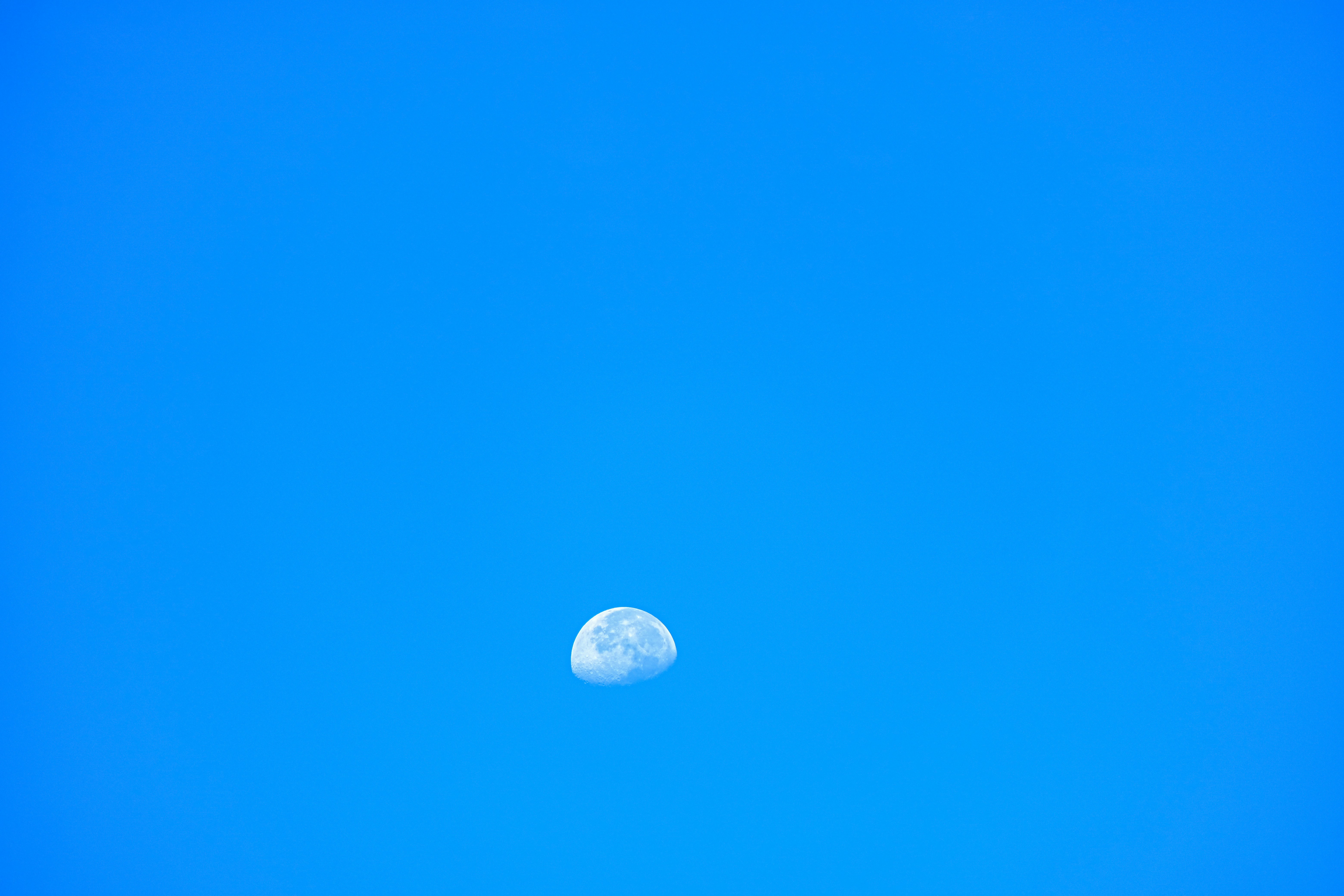 Lone Moon in a Cerulean Expanse