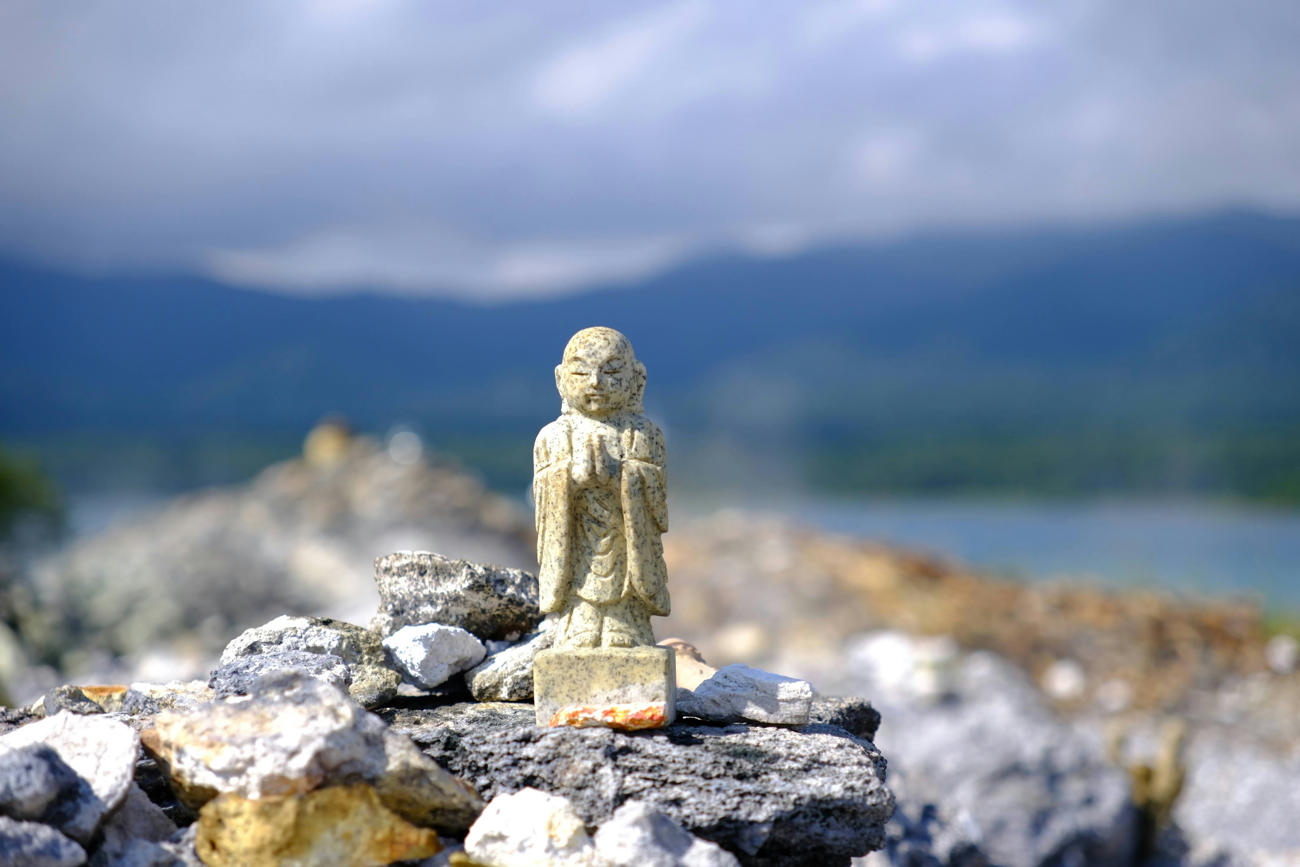 Weathered Stone Sentinel Overlook by a Quiet Lake