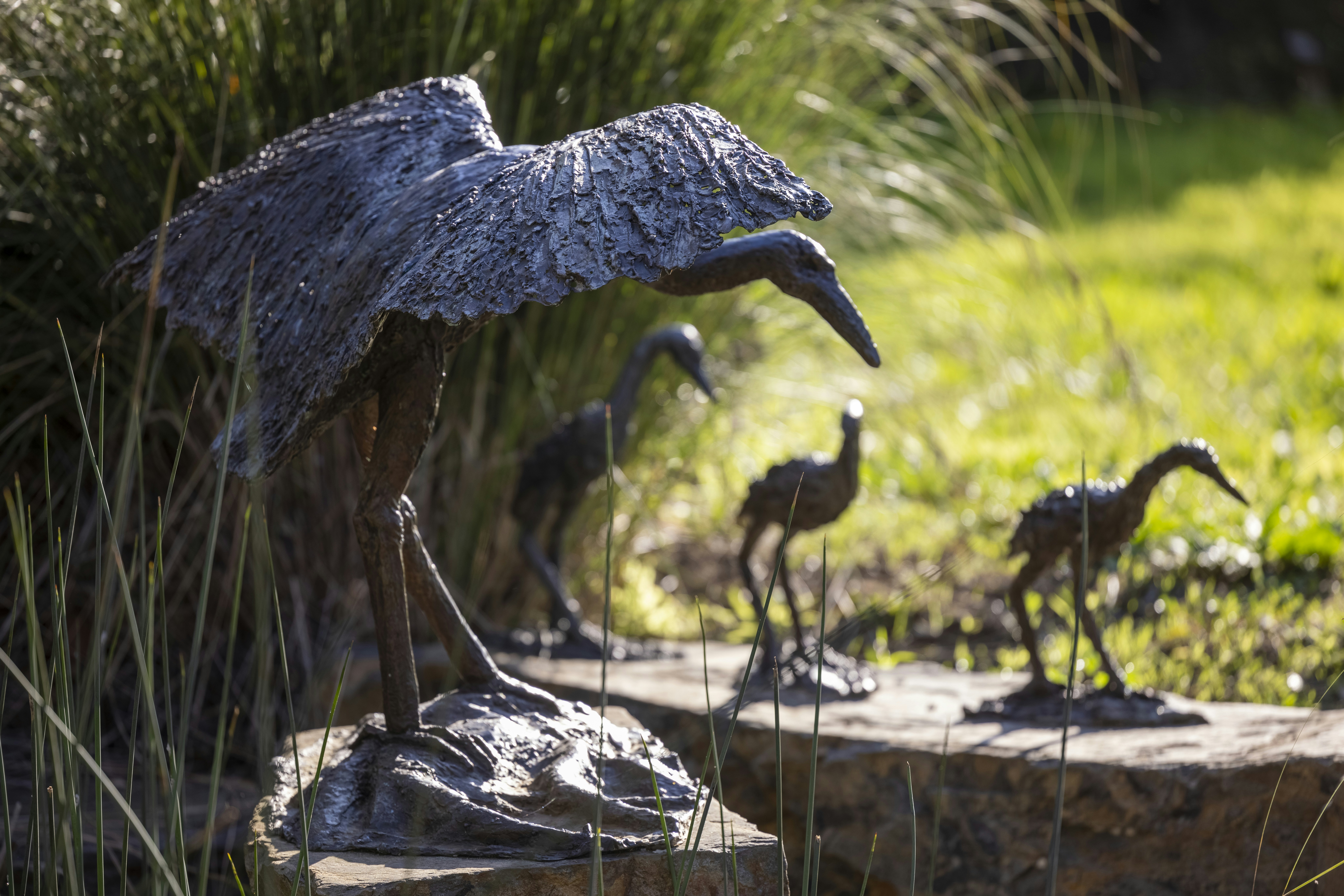 Whispers of the Wetland: A Row of Patinaed Herons