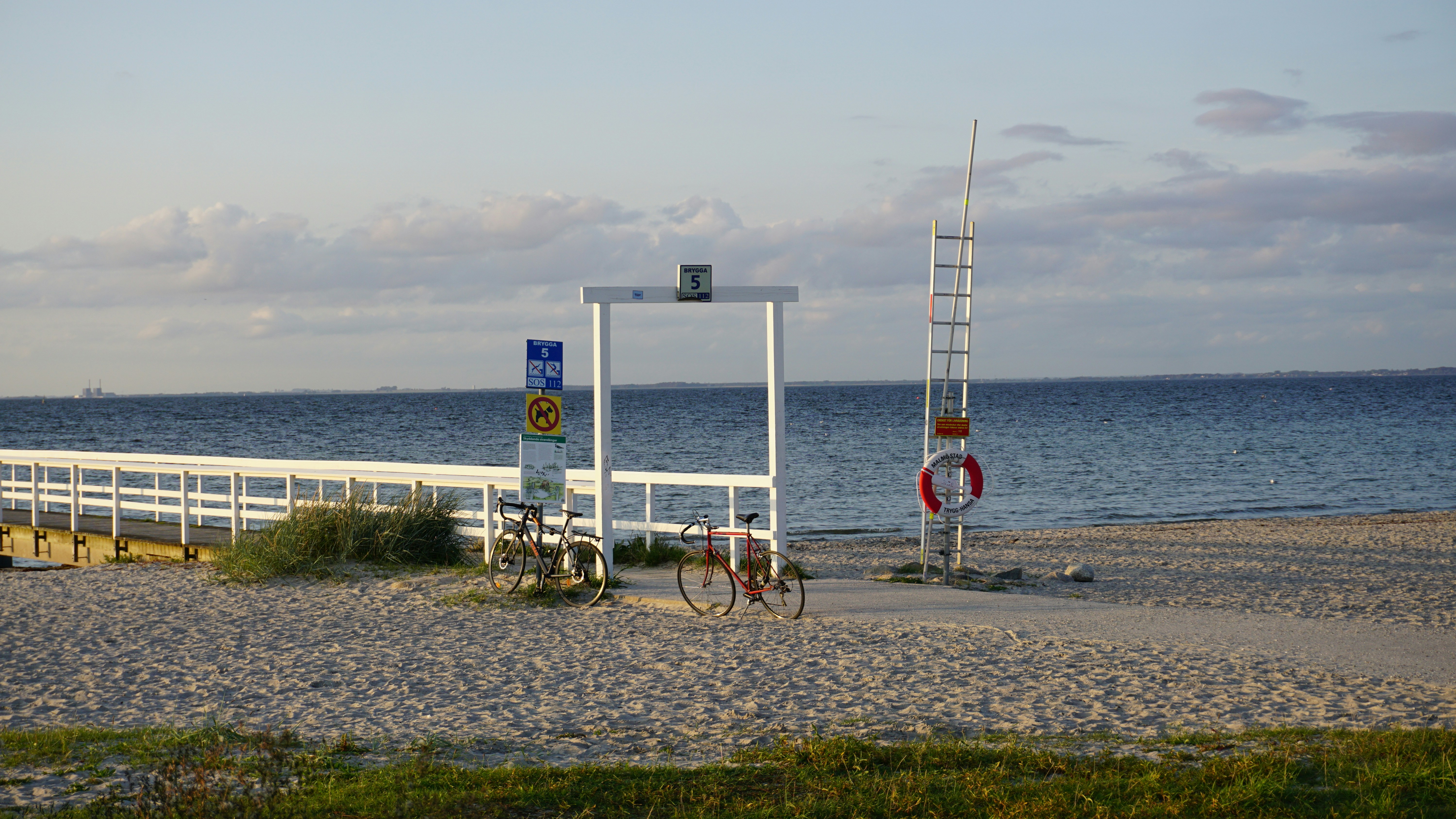 Lifebuoy Gate by the Seaside: Bicycles and a Quiet Horizon